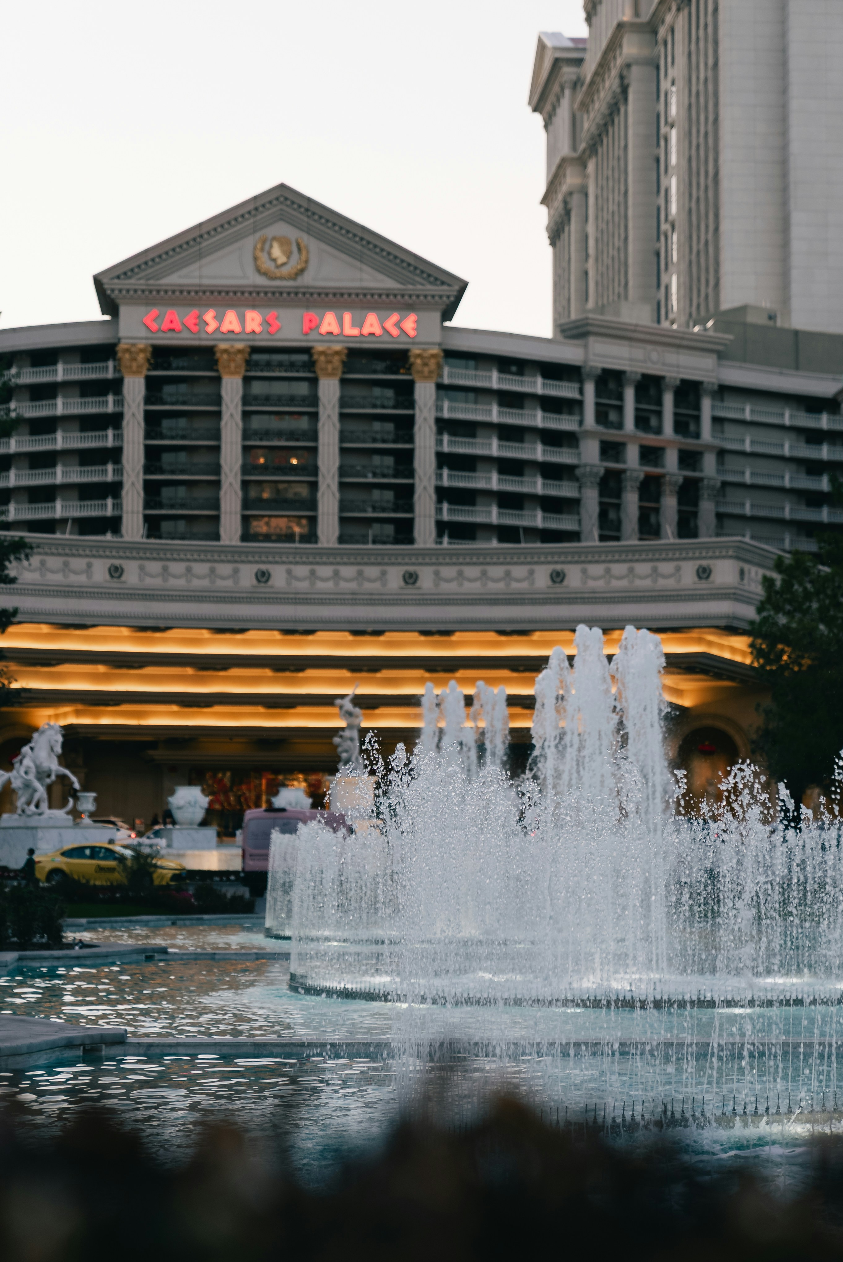 Caesars Palace Fountains Beneath Neon Signage