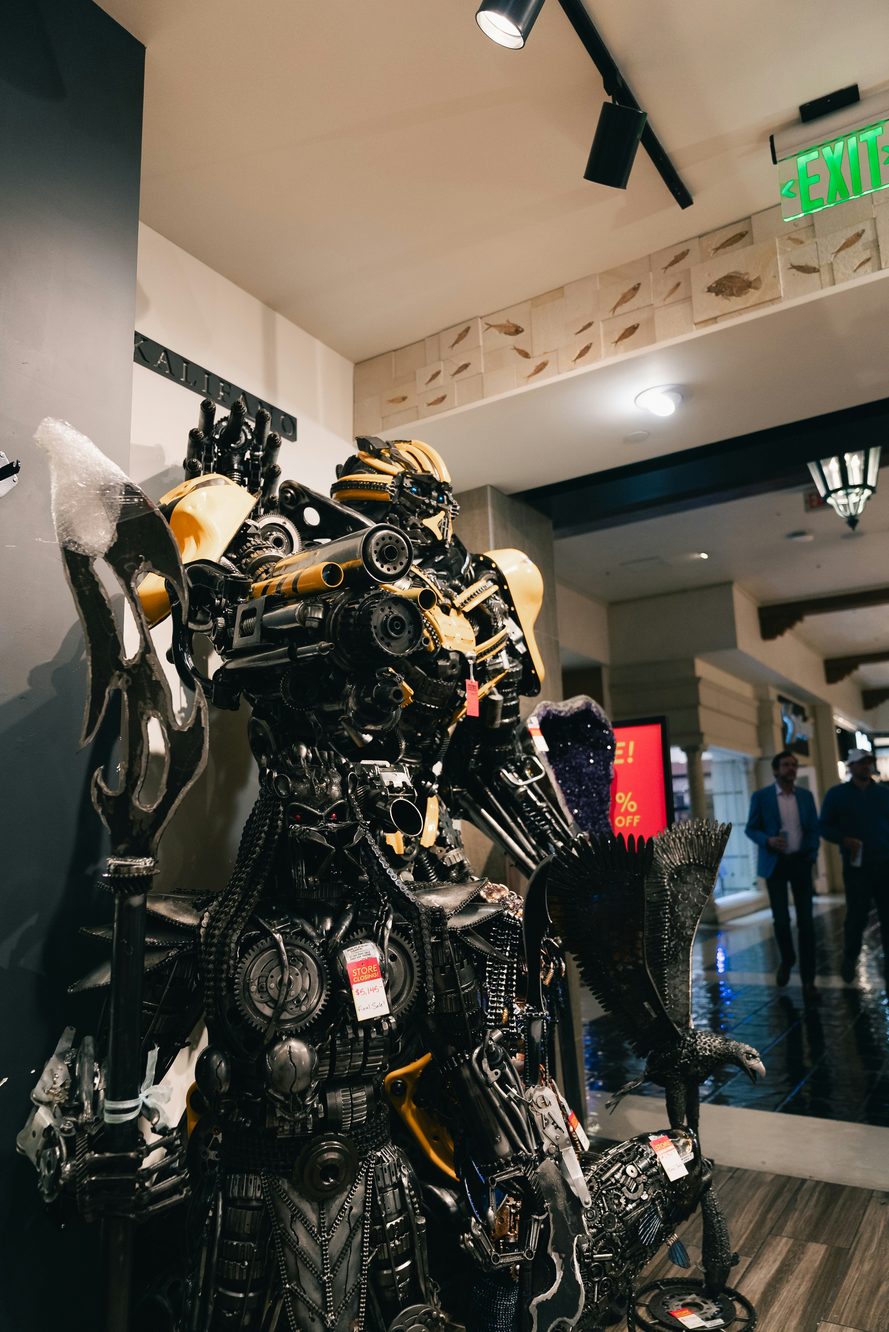 Mech Warrior on Display: A Gleaming Titan Amid Storefront Lights