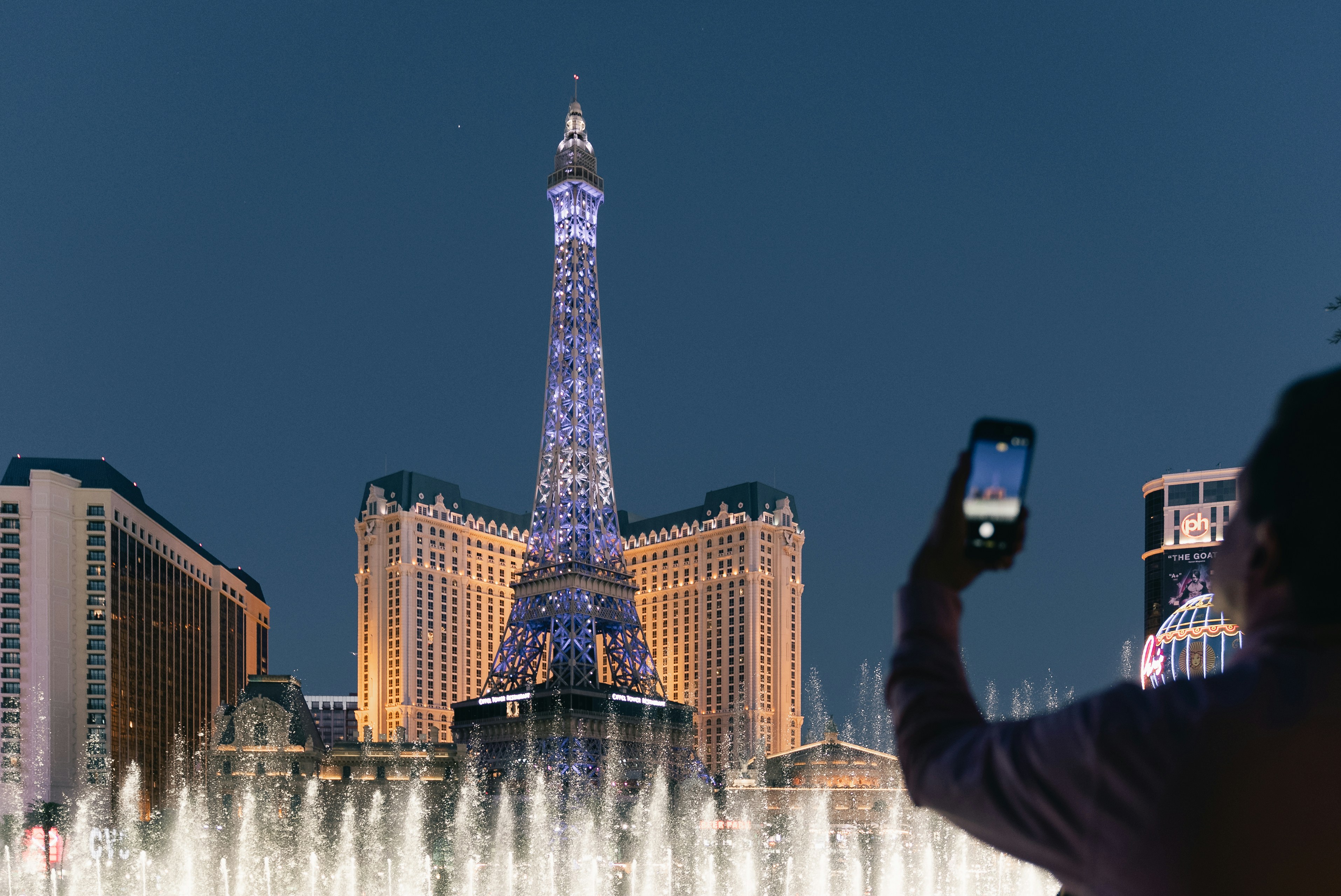 Towering Glow: Eiffel-inspired landmark framed by a cheering crowd