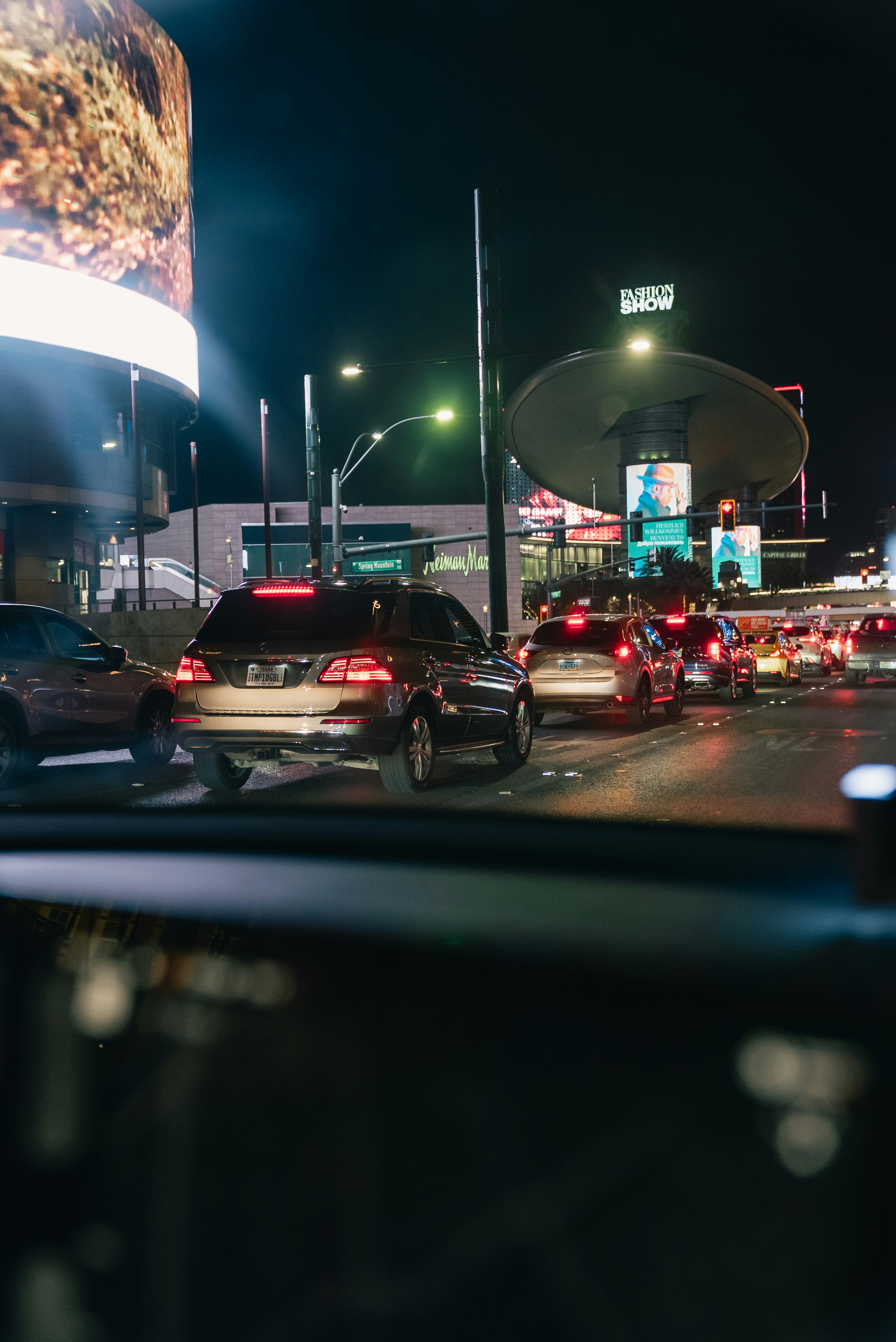 Night Traffic Converges at the Circular Bus Stop Canopy