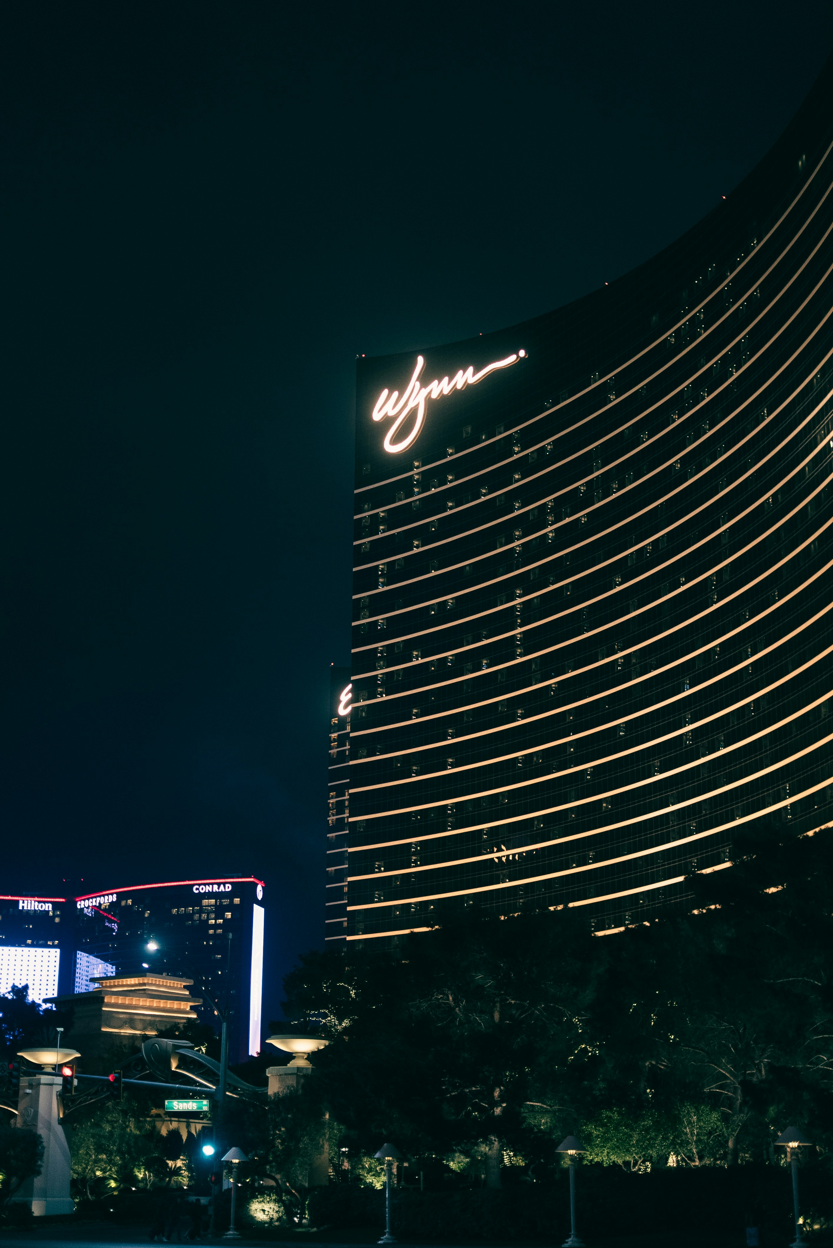Neon Arc: The Winding Facade of Night in a Silk-City Skyline