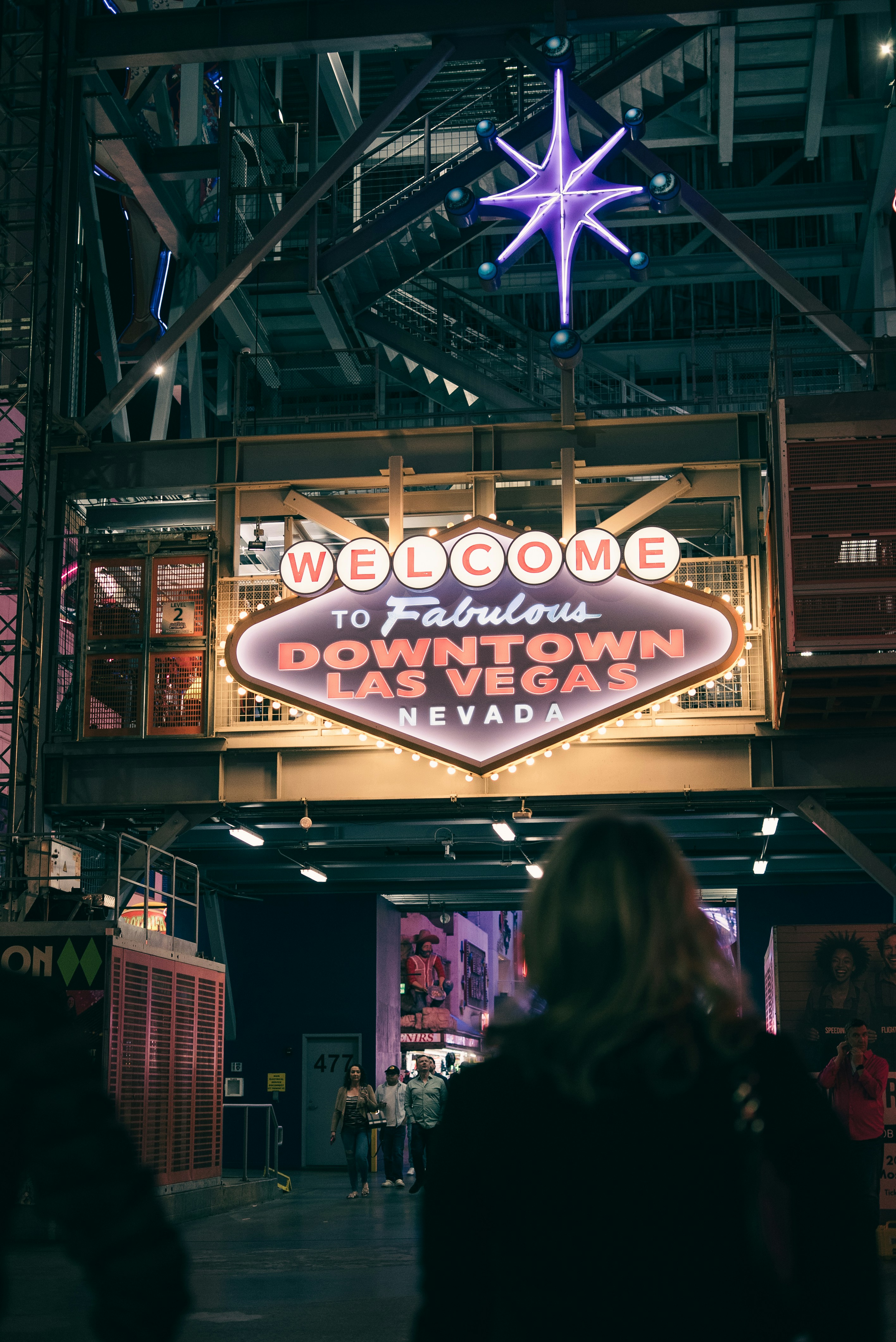 Neon Welcome: Vegas Sign Framed by Shadowed Visitors