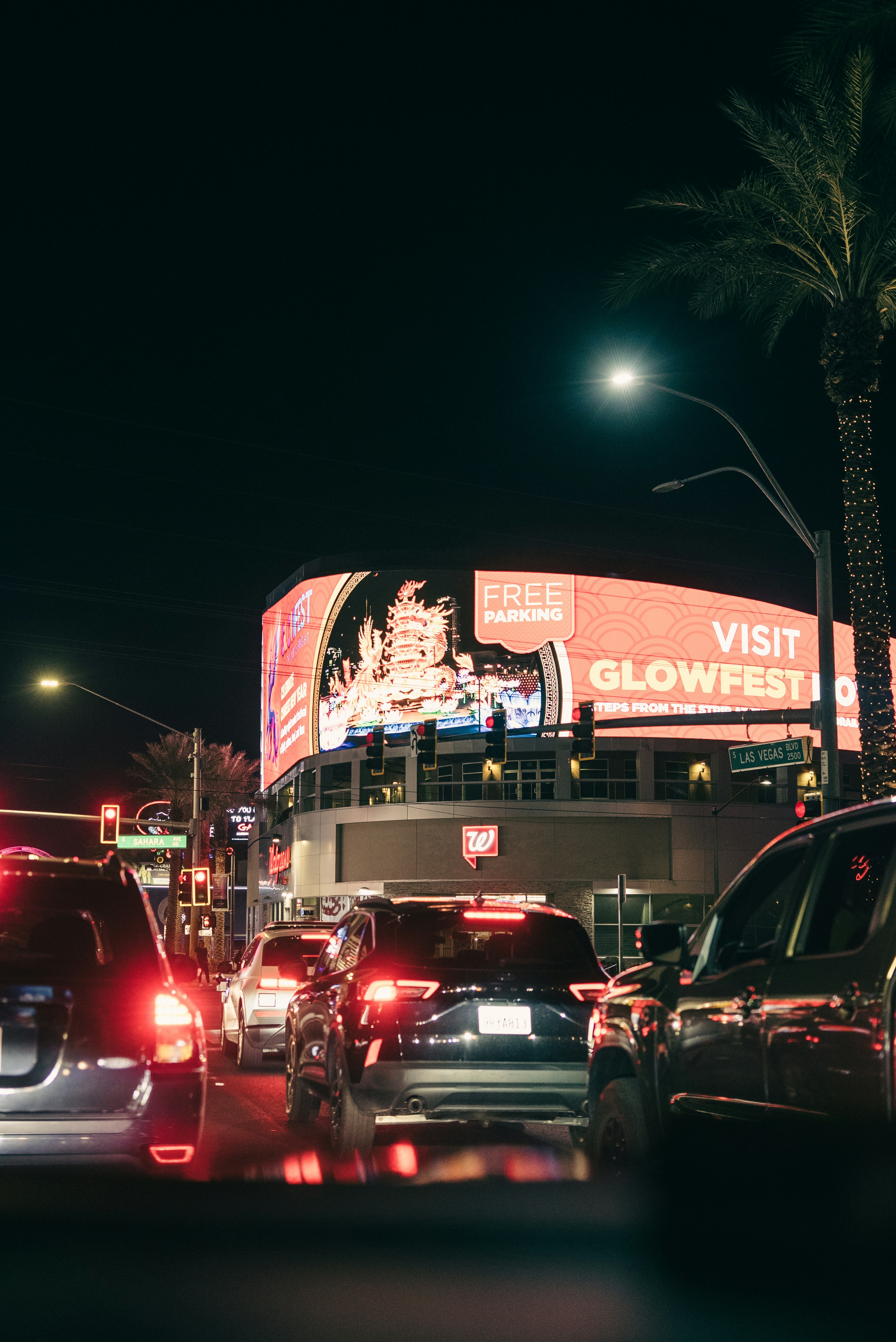 Neon Boulevard: Night Traffic Converges Under a Grand Billboard