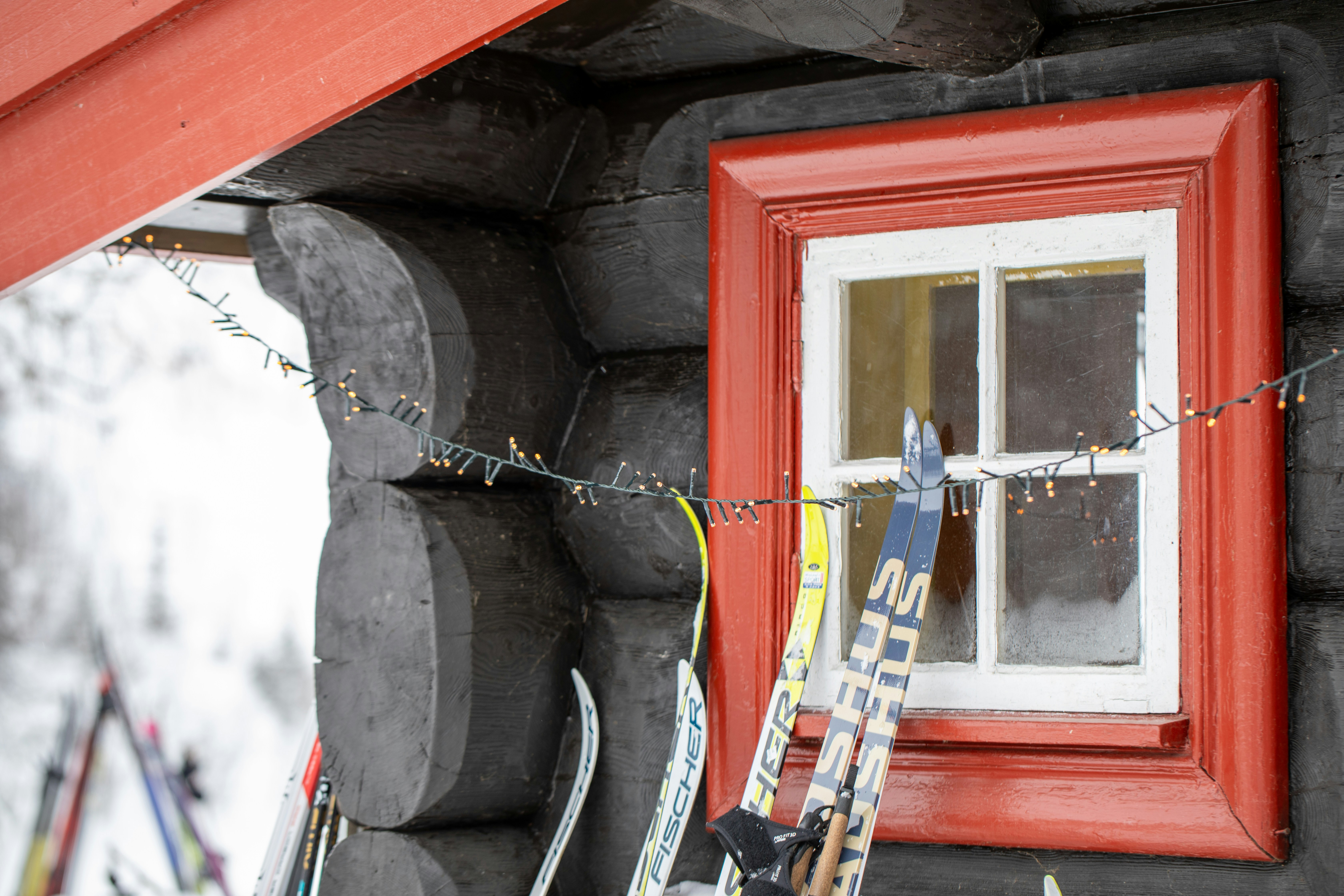 Red Window, Black Cabin, and Floating Skis