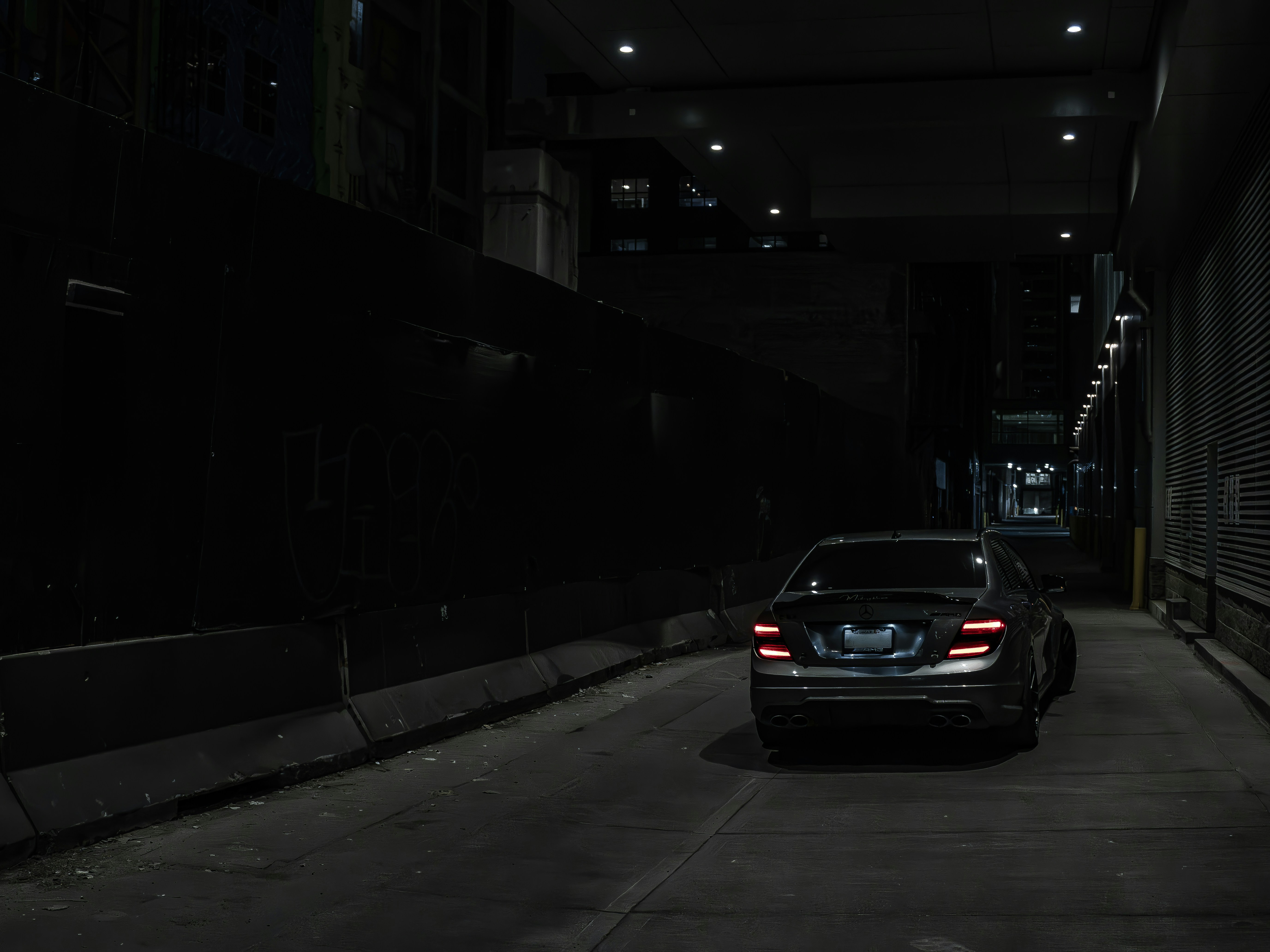 Night Drive: A Silver Sedan Recedes Through an Urban Corridor