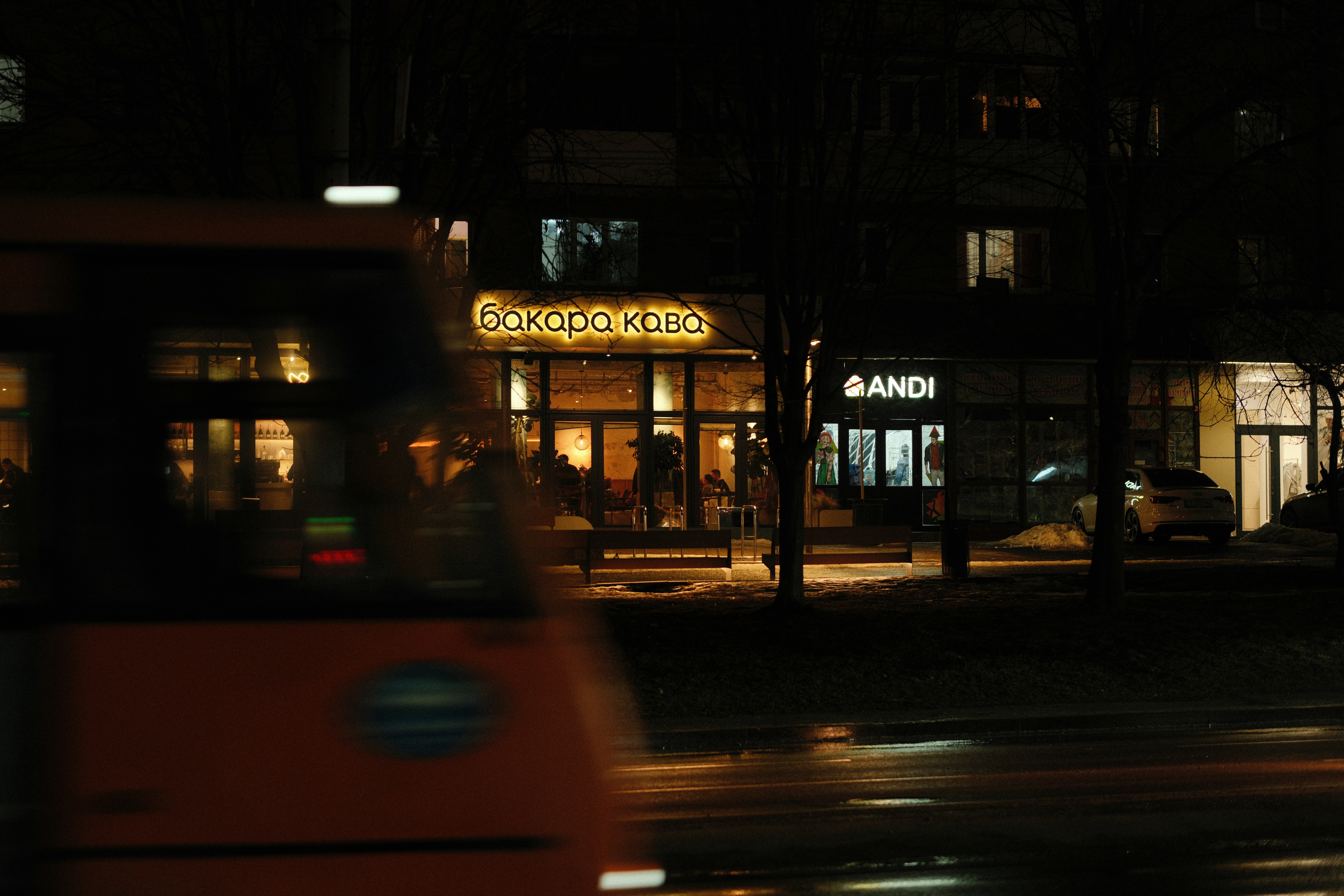 Night Bus Glimpse: Neon Signatures Over a Quiet Street