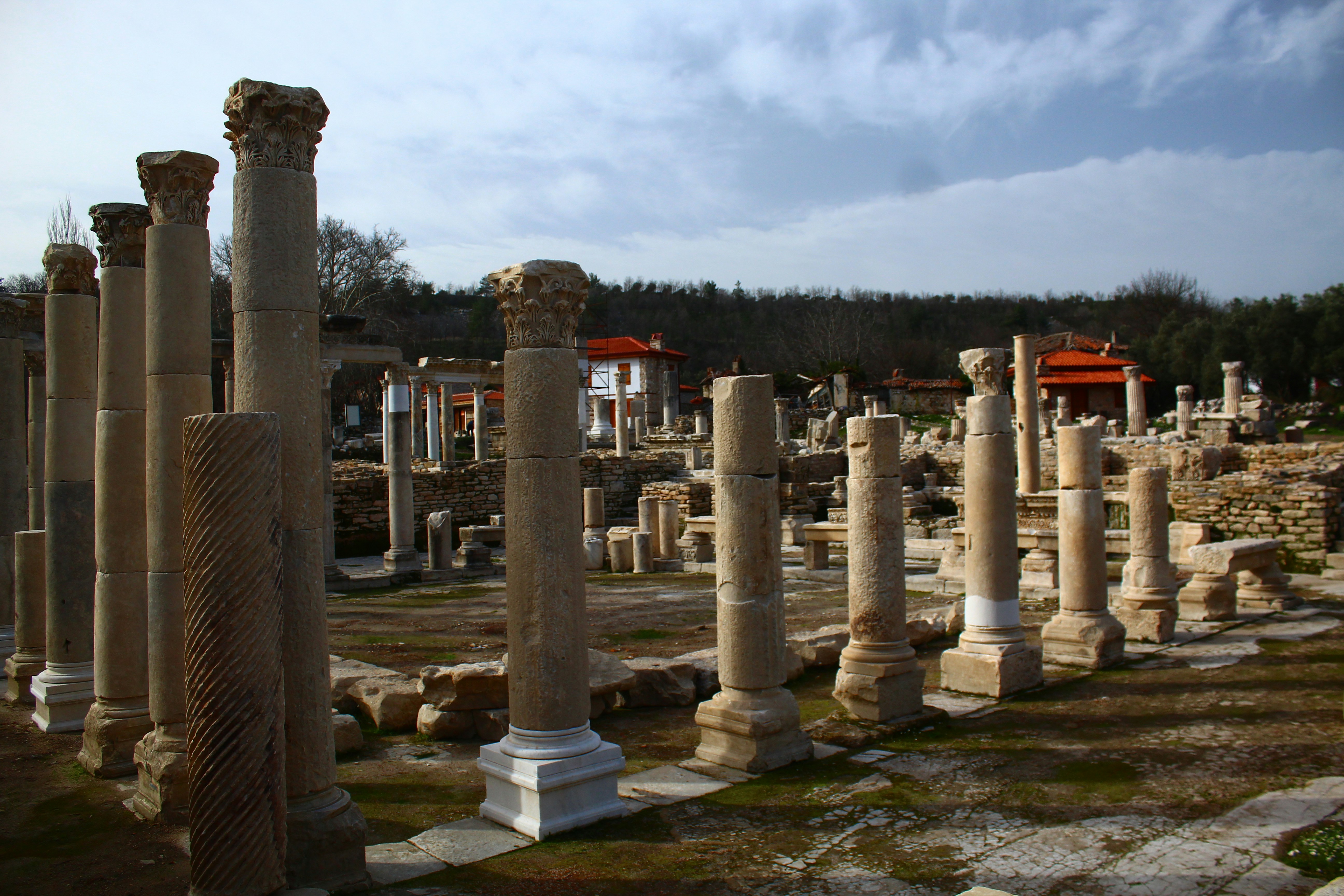 Columns of time: a sunlit colonnade beneath a wide open sky