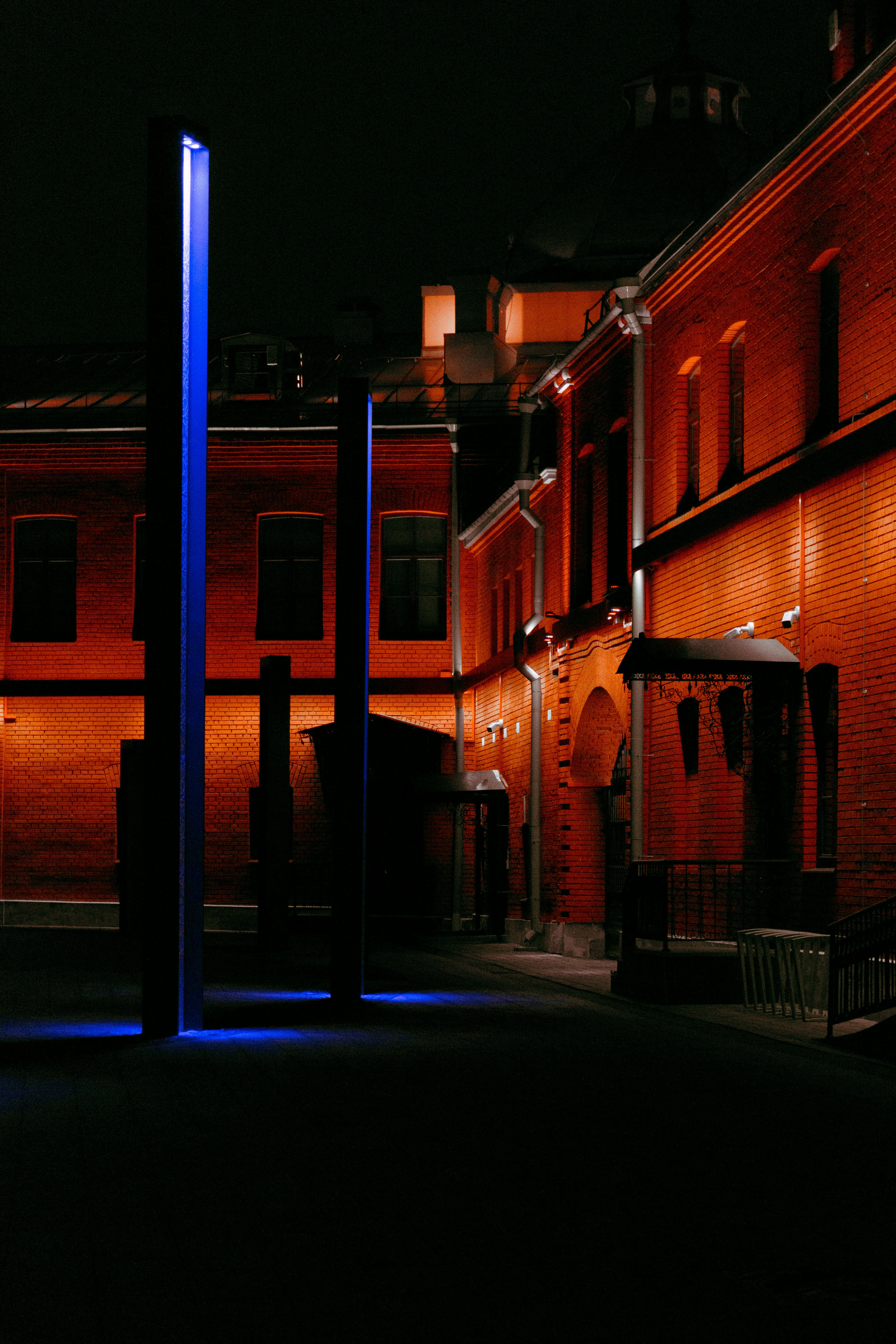 Night Runway of Brick and Neon Columns