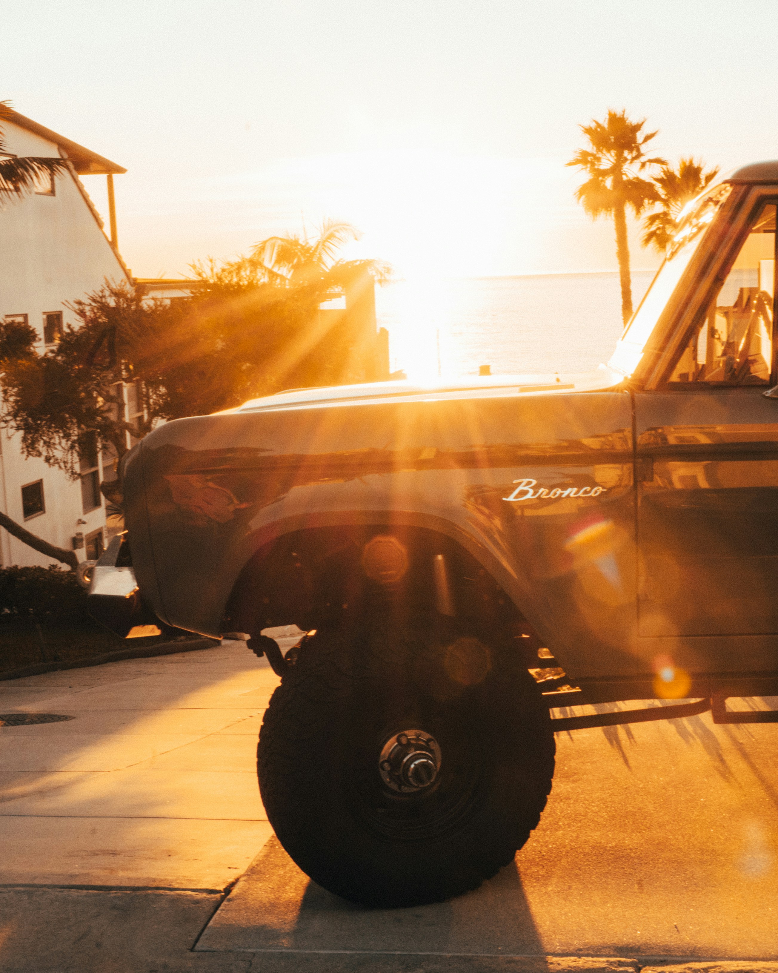 Sunlit Bronco: A Vintage Truck Backdropped by a Pacific Dawn