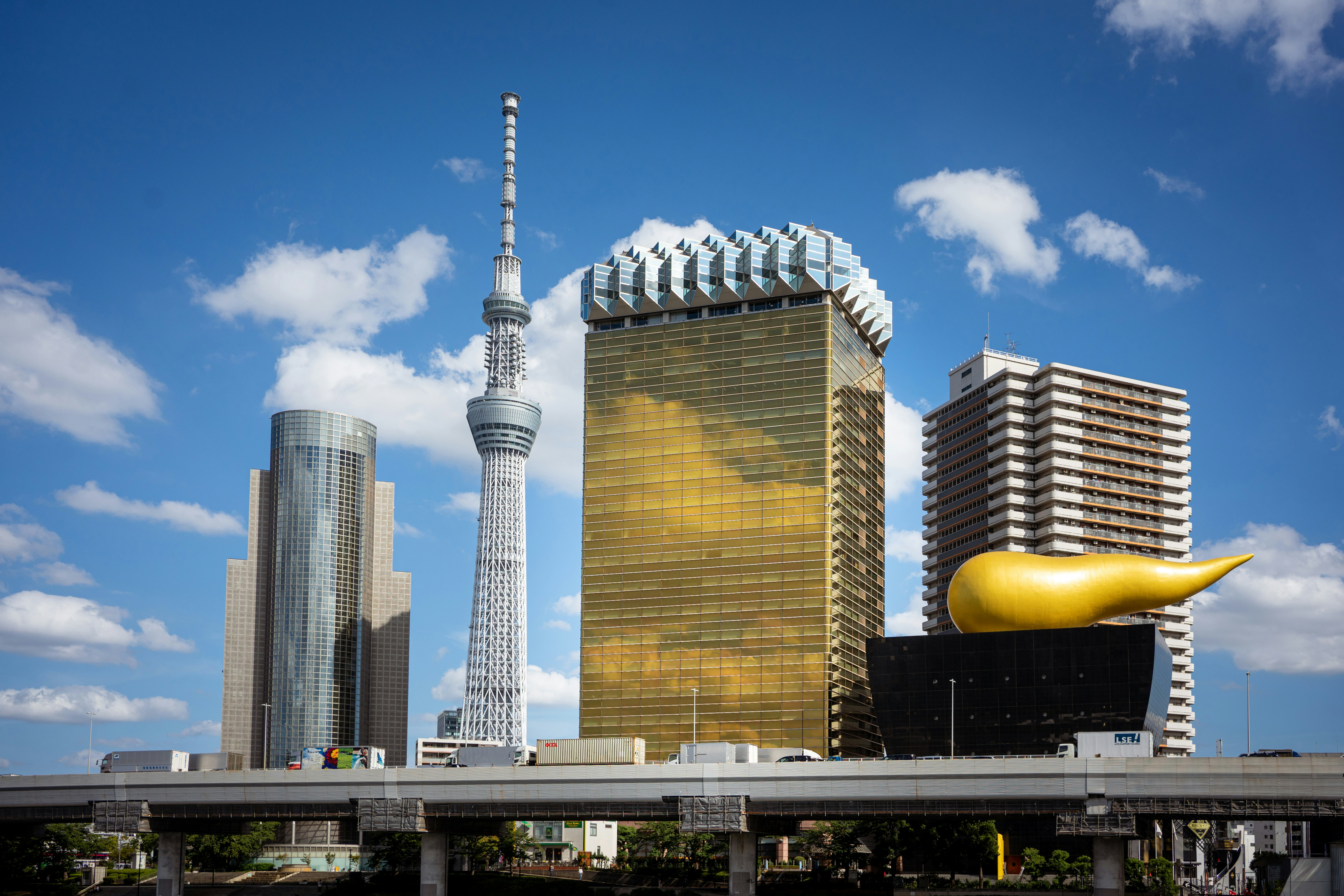 Golden Skyline: The Gold-tinted Tower Amid Modern Giants