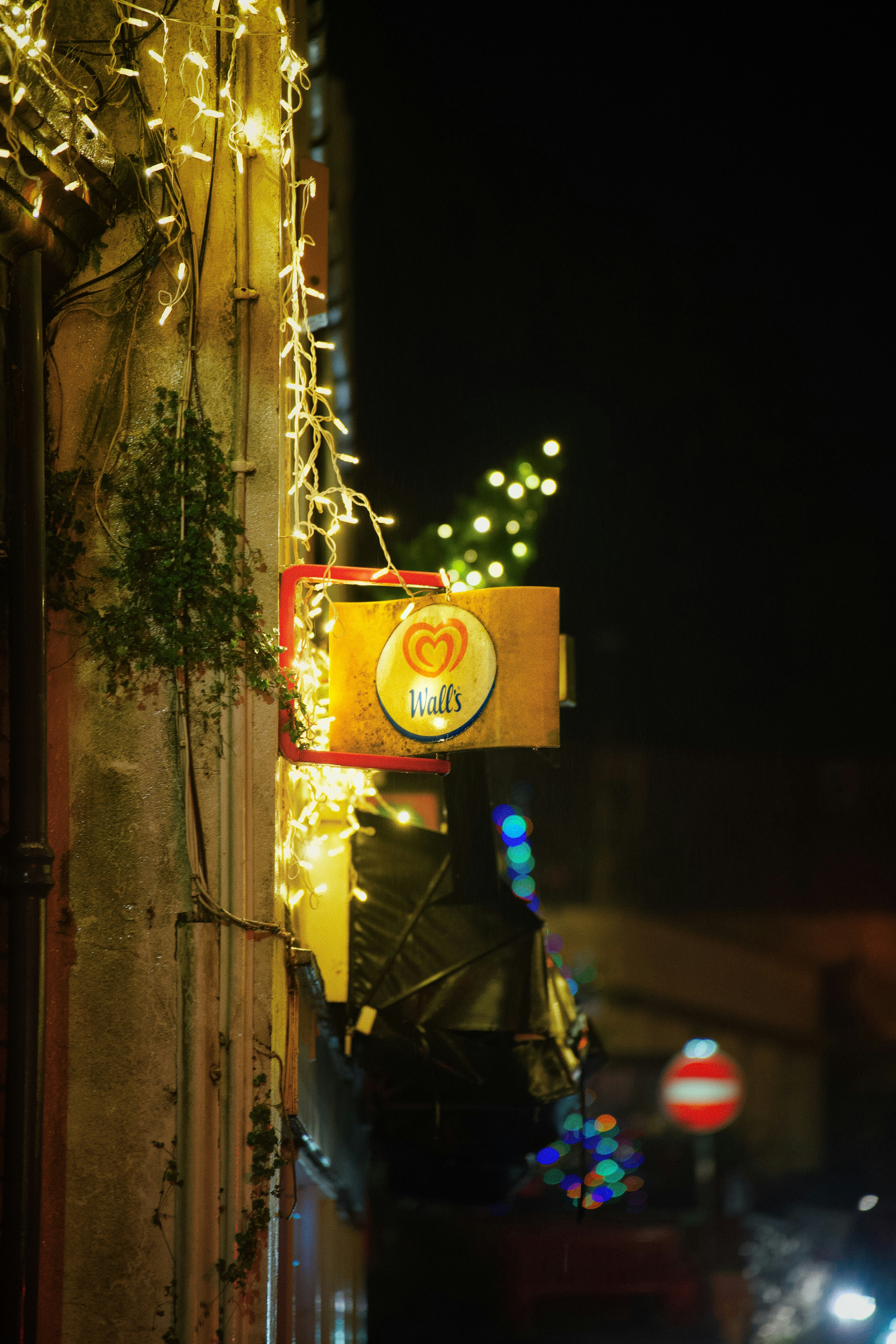 Warm Neon Toast: A Lit Sign on a Cozily Lit Street