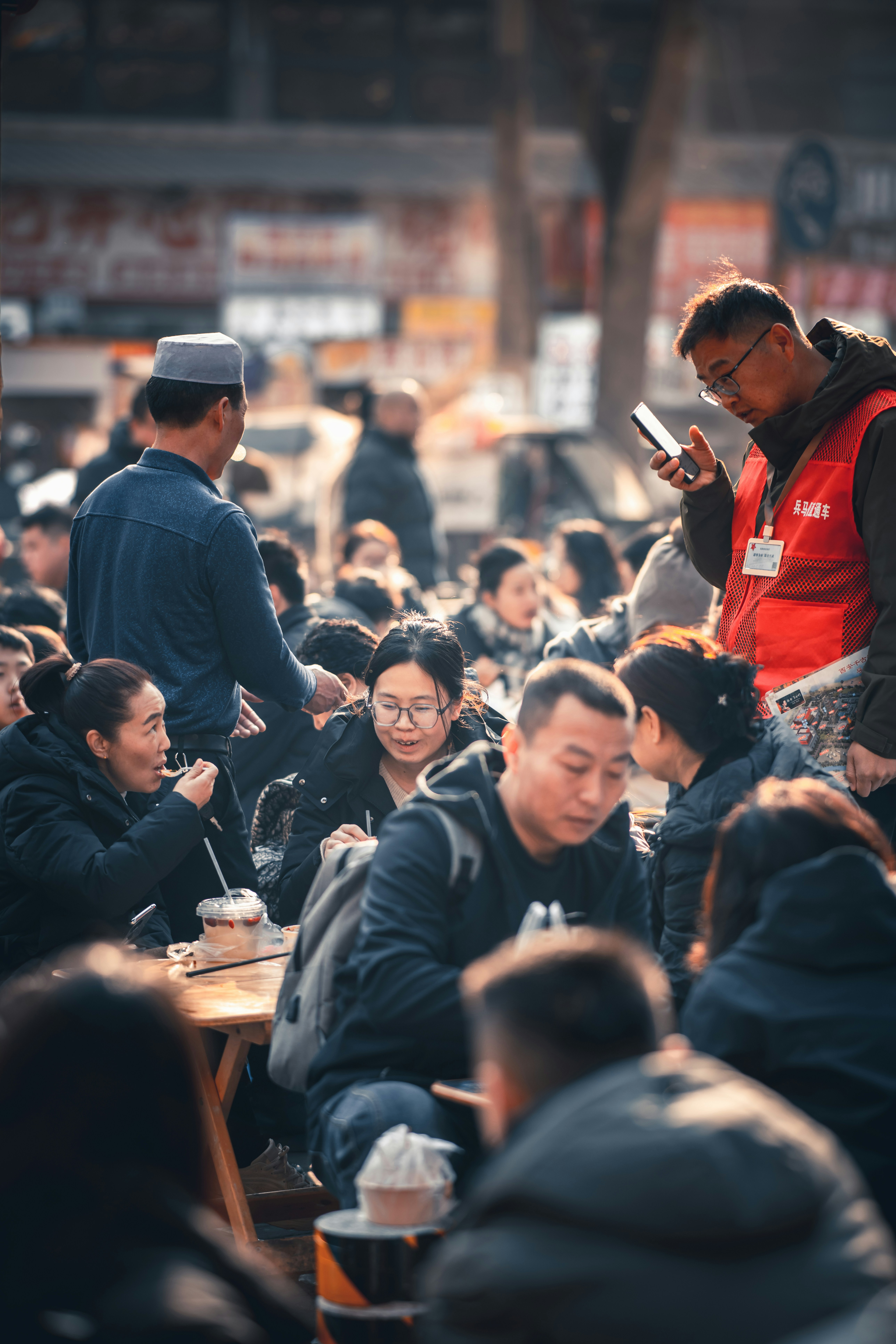 Crossed Interests: A crowded street-food moment under a rising sun