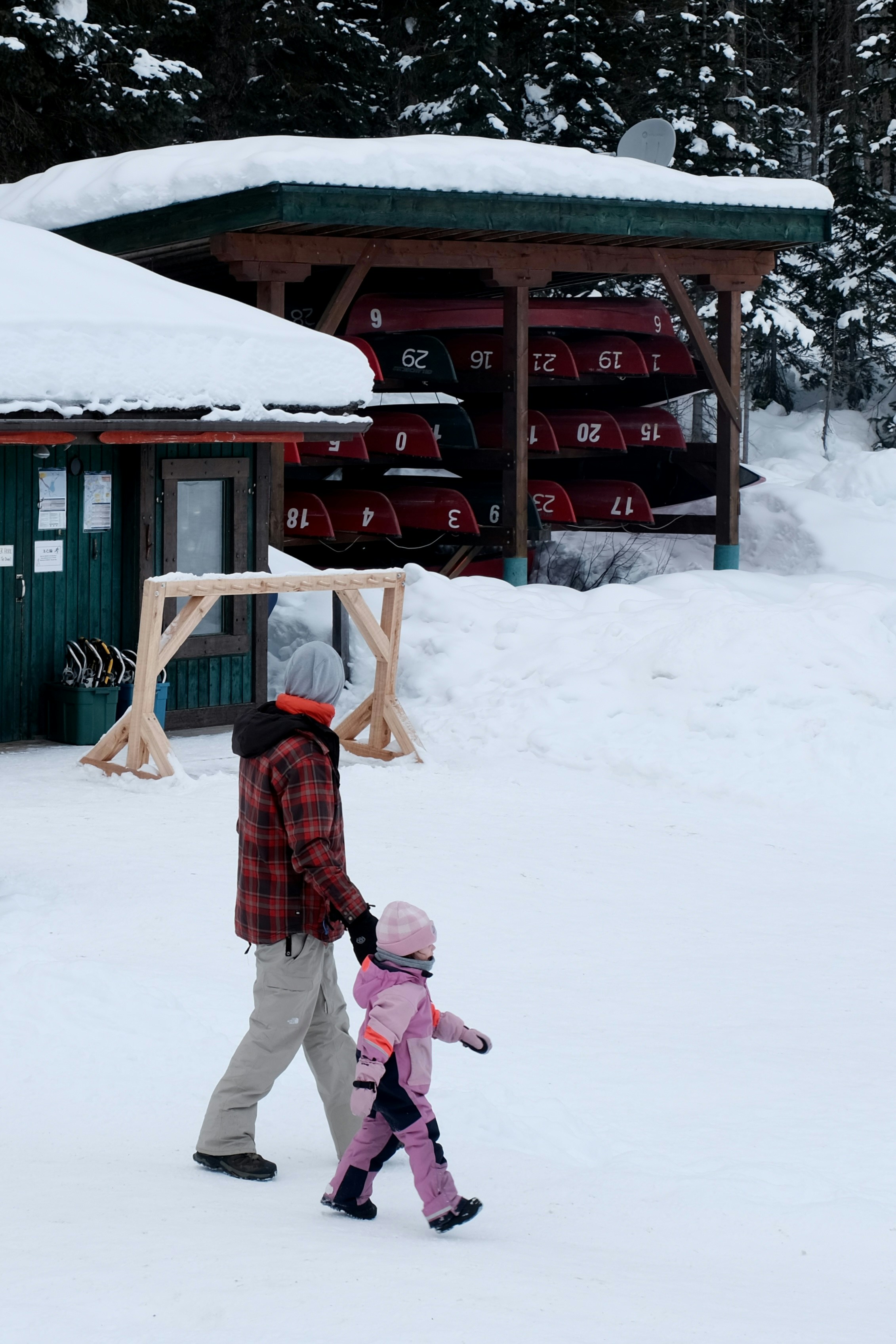 Winter Walk: A Parent and Child Against the Snowy Backdrop