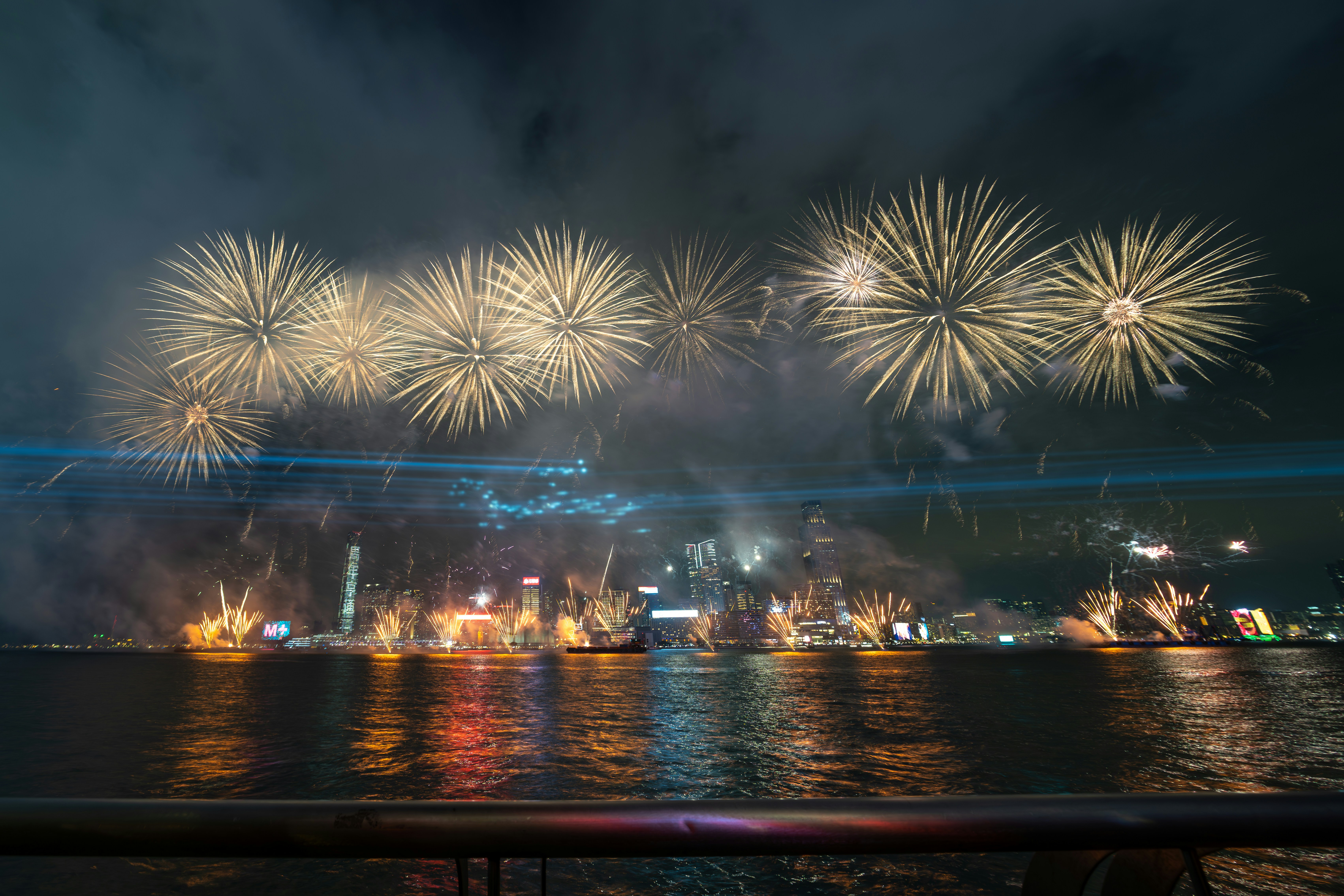 Overwater Bloom: Fireworks Over a Moonlit Harbor