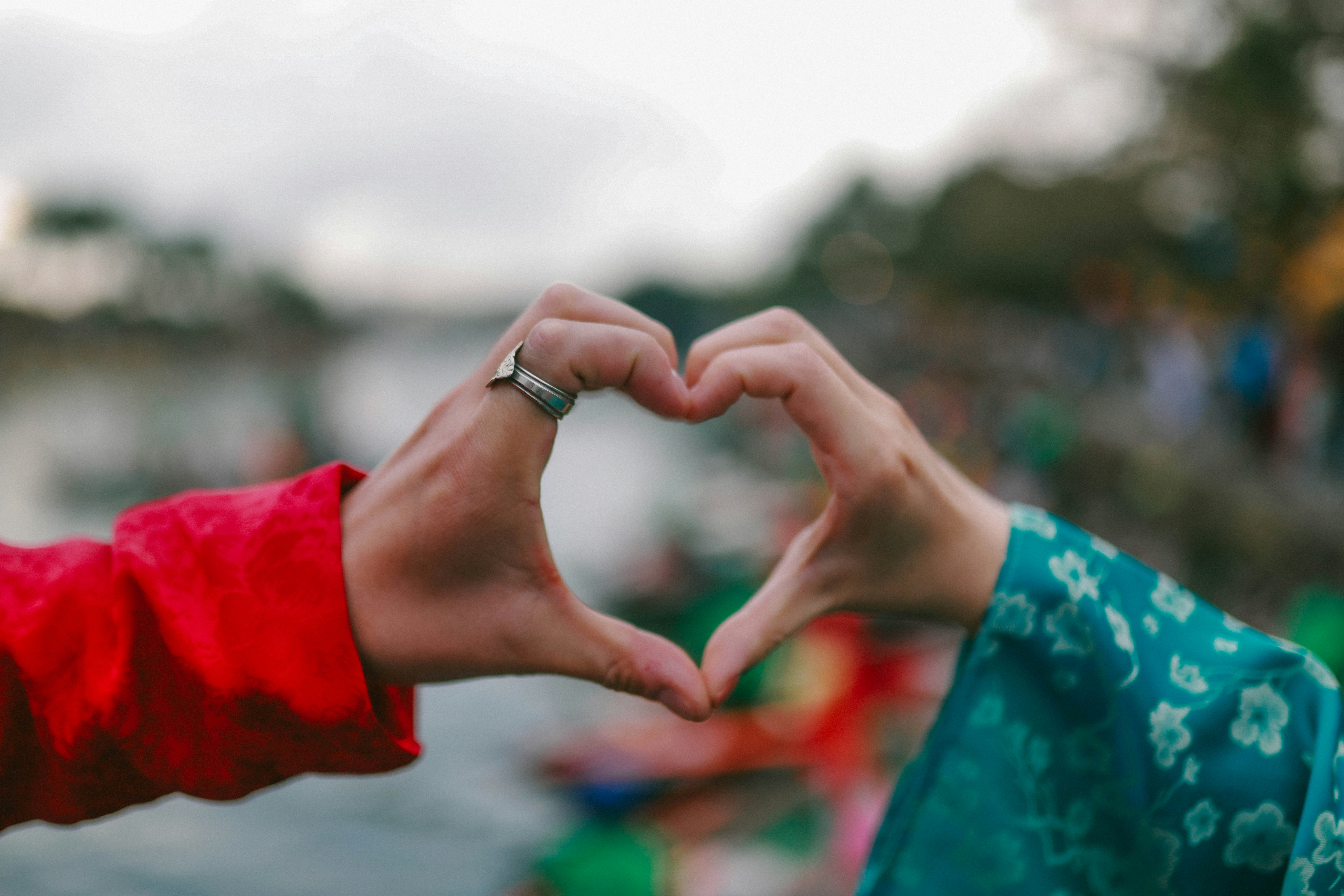 Heart by the River: Hands Form a Pinky-Heart As the Scene Warms