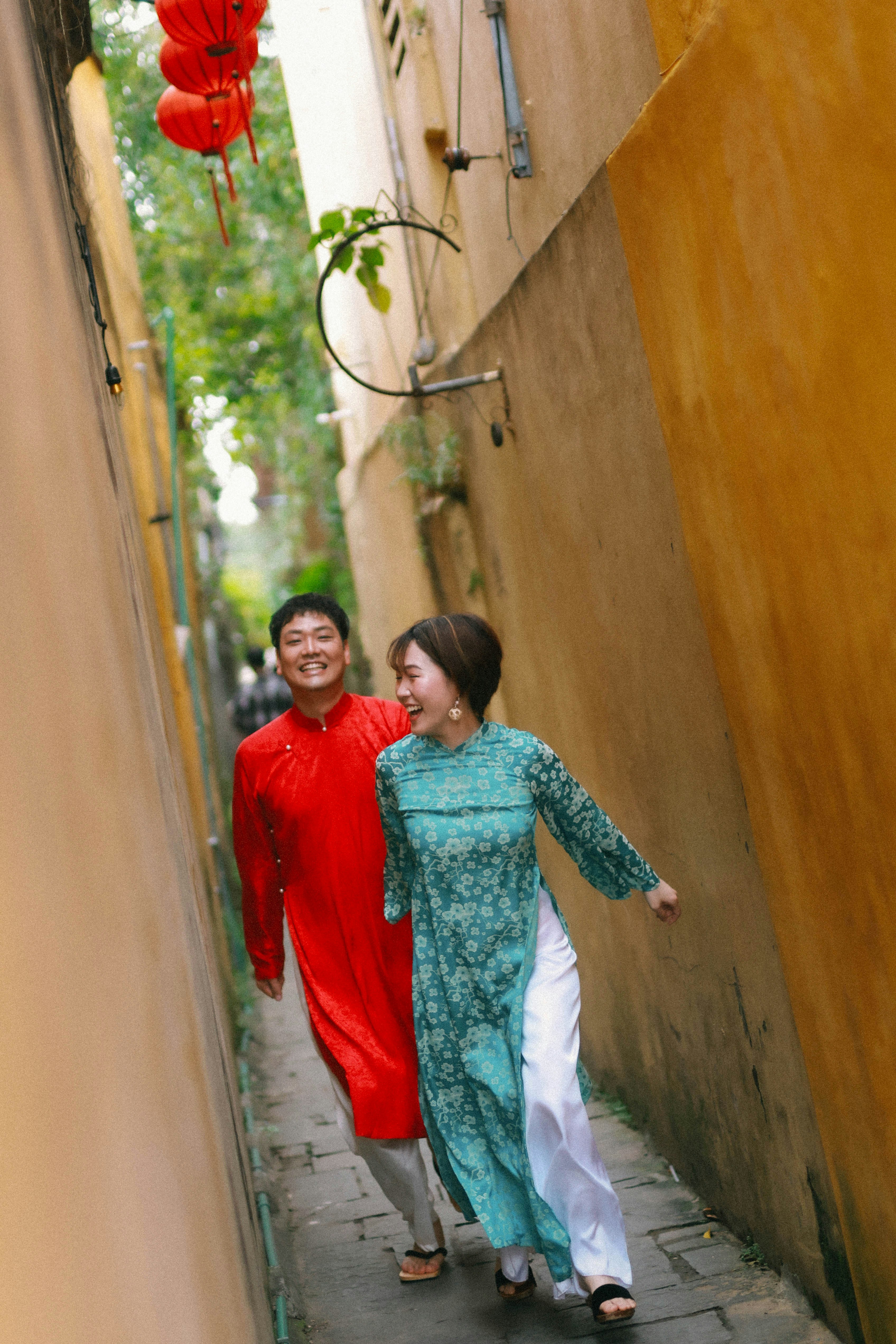 Happiness in a Sunlit Alley: A Duo in Traditional Attire