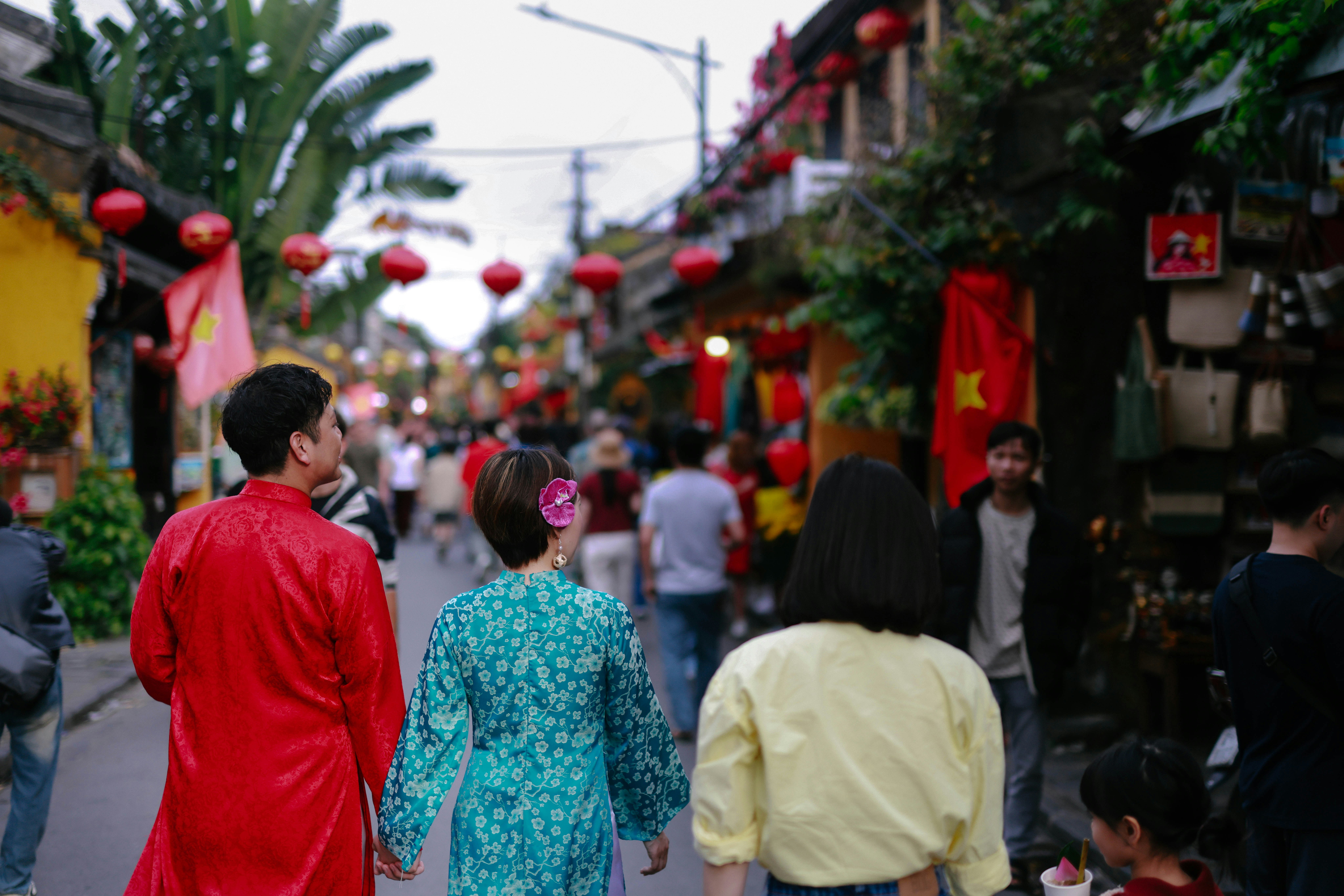 Colorful Street Crossing: A Trio in Traditional Attire Walks Into Focus