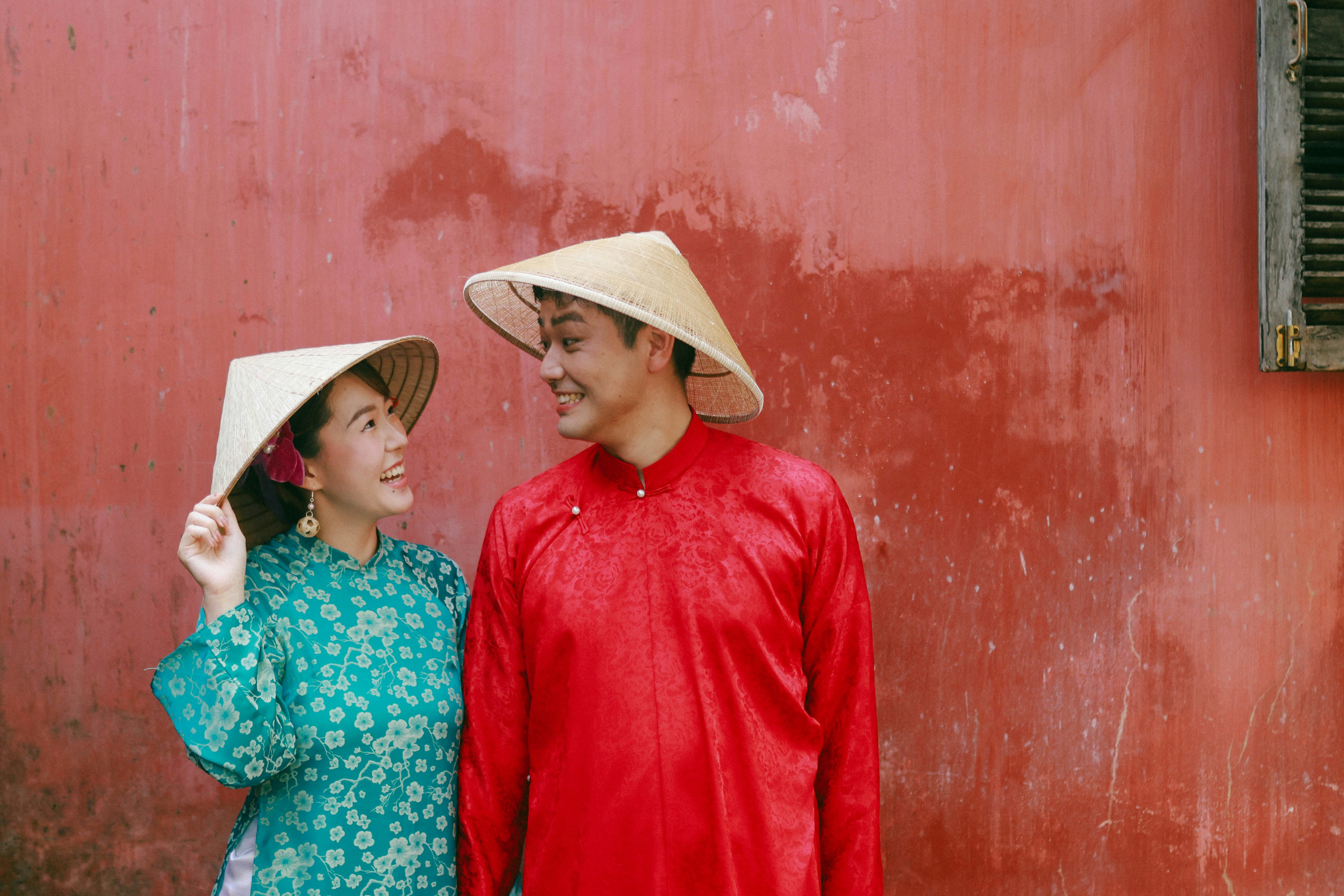 Crimson Wall, Gentle Grins: A Shared Moment in Red and Teal