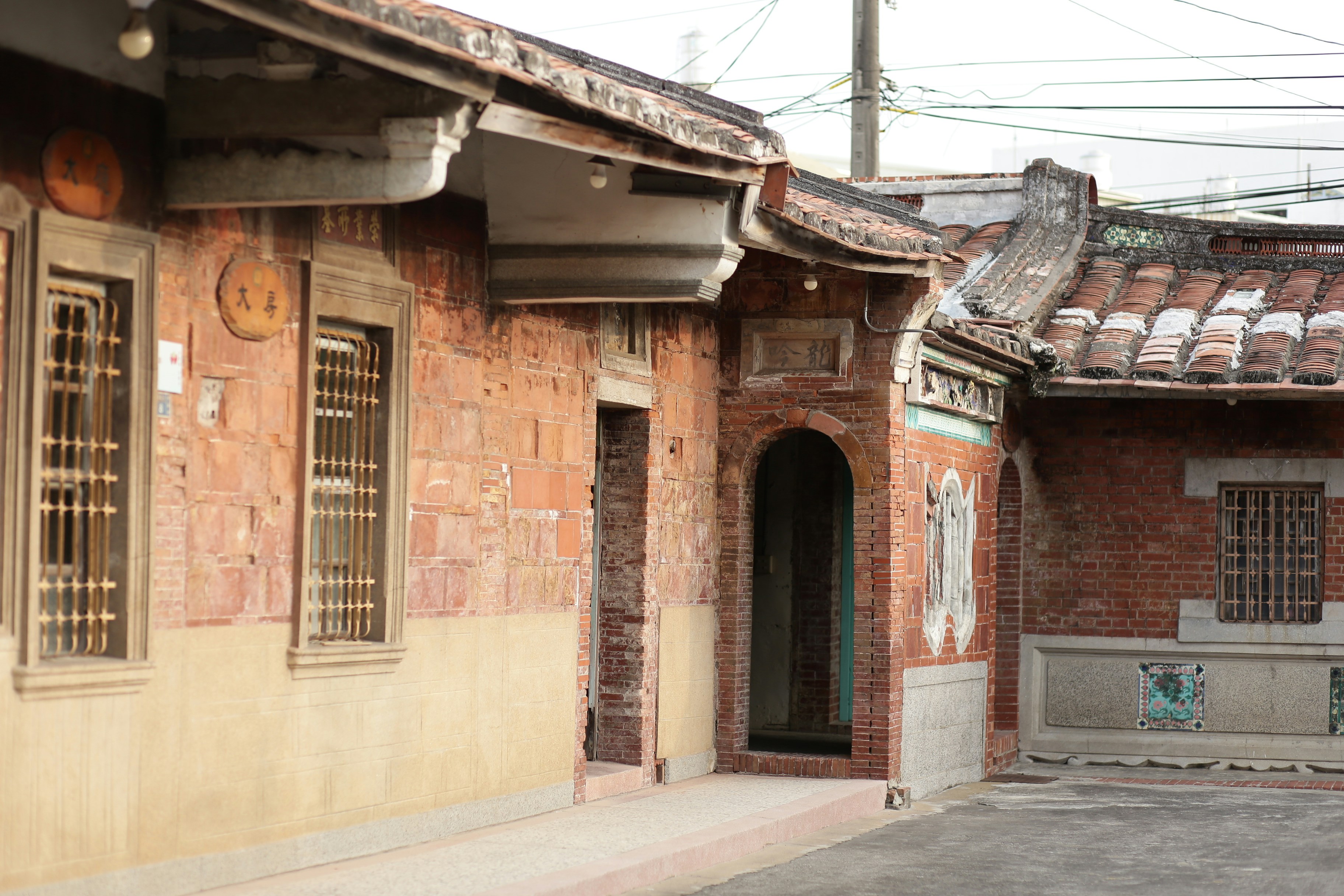 Sunlit Courtyard Arches of a Quiet Brick Alley