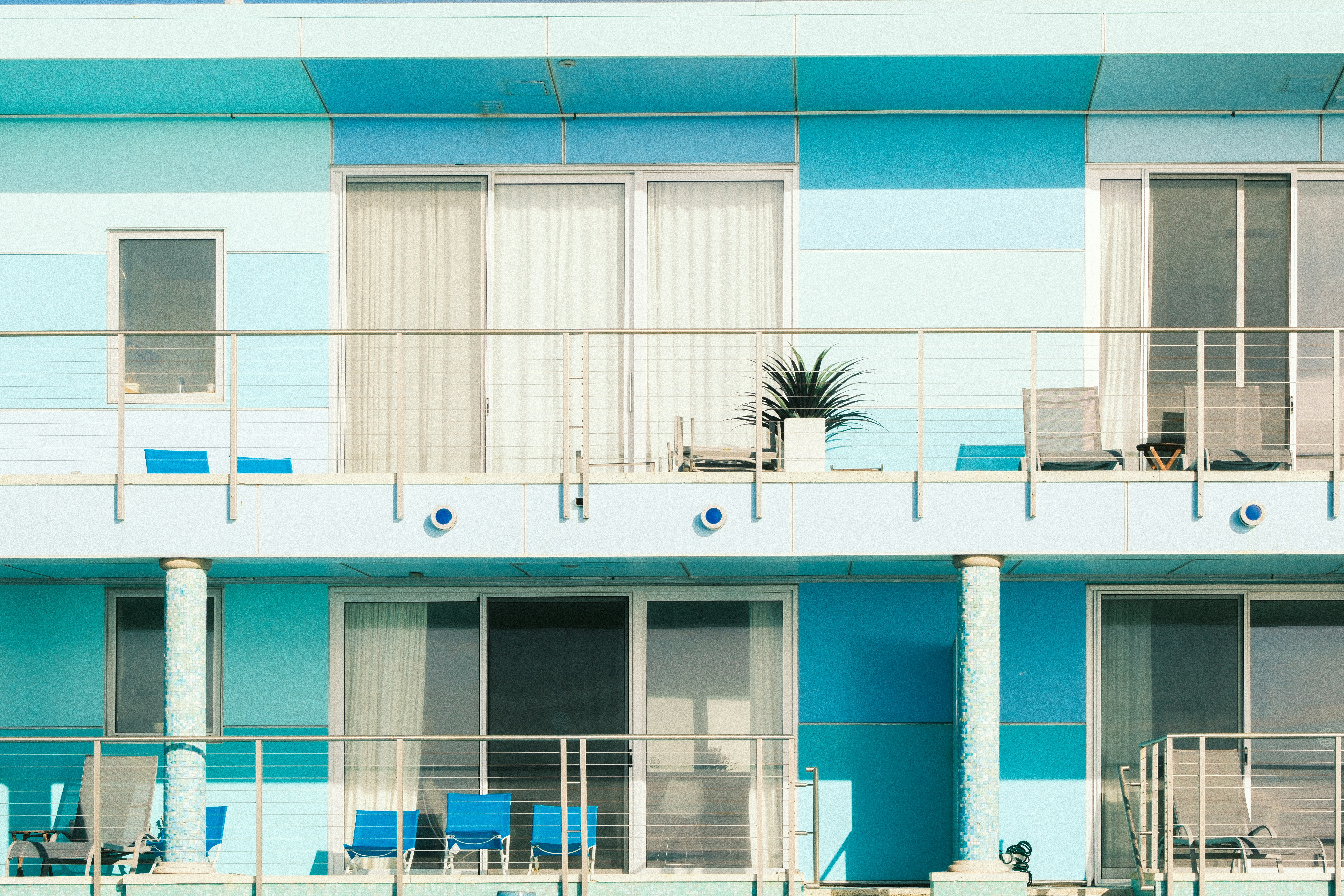Azure Balcony Facade: Banding and Light on a Seaside Motel