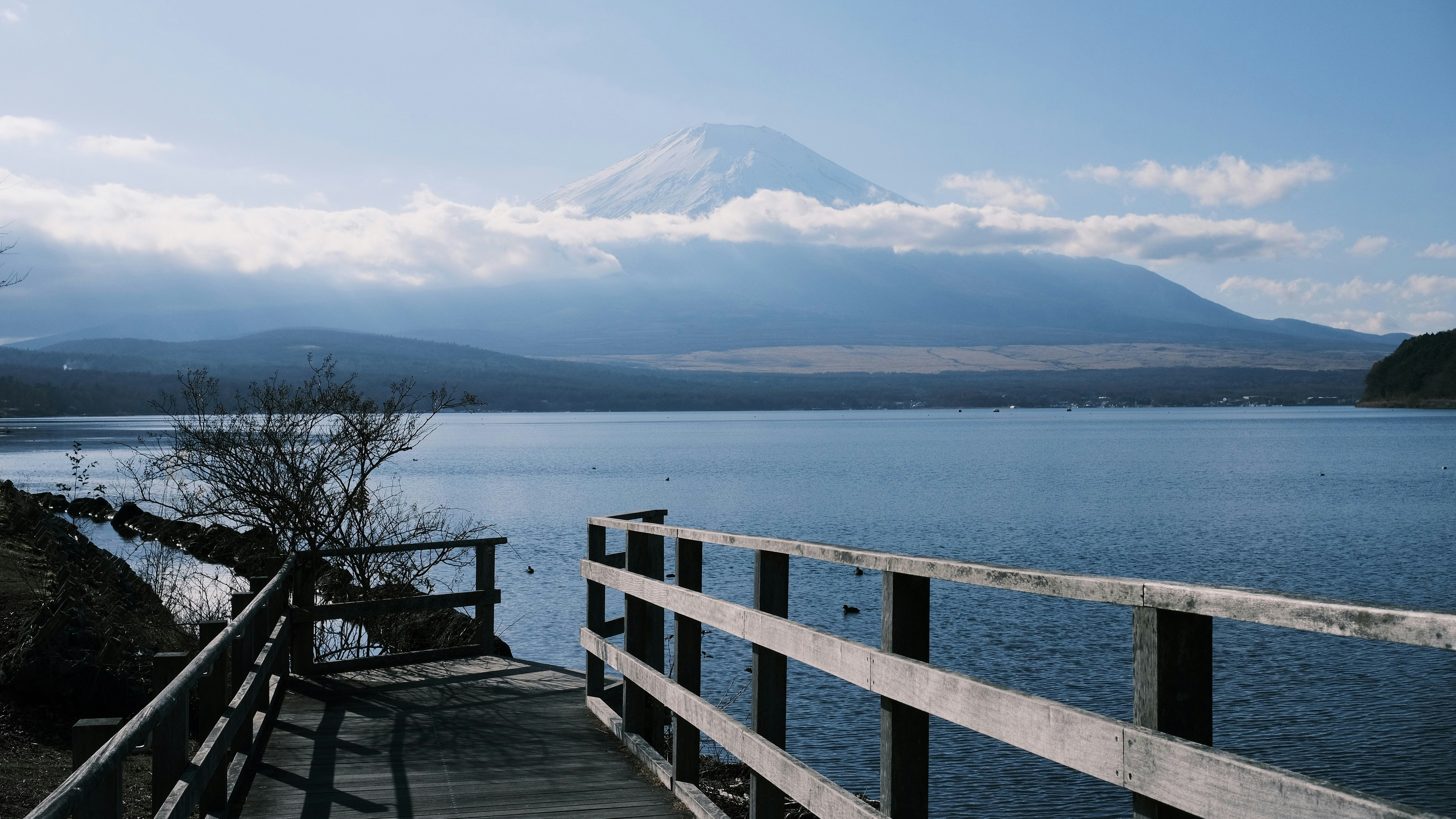 Mount Fuji Looming Over a Quiet Lake, Framed by a Wooden Pier