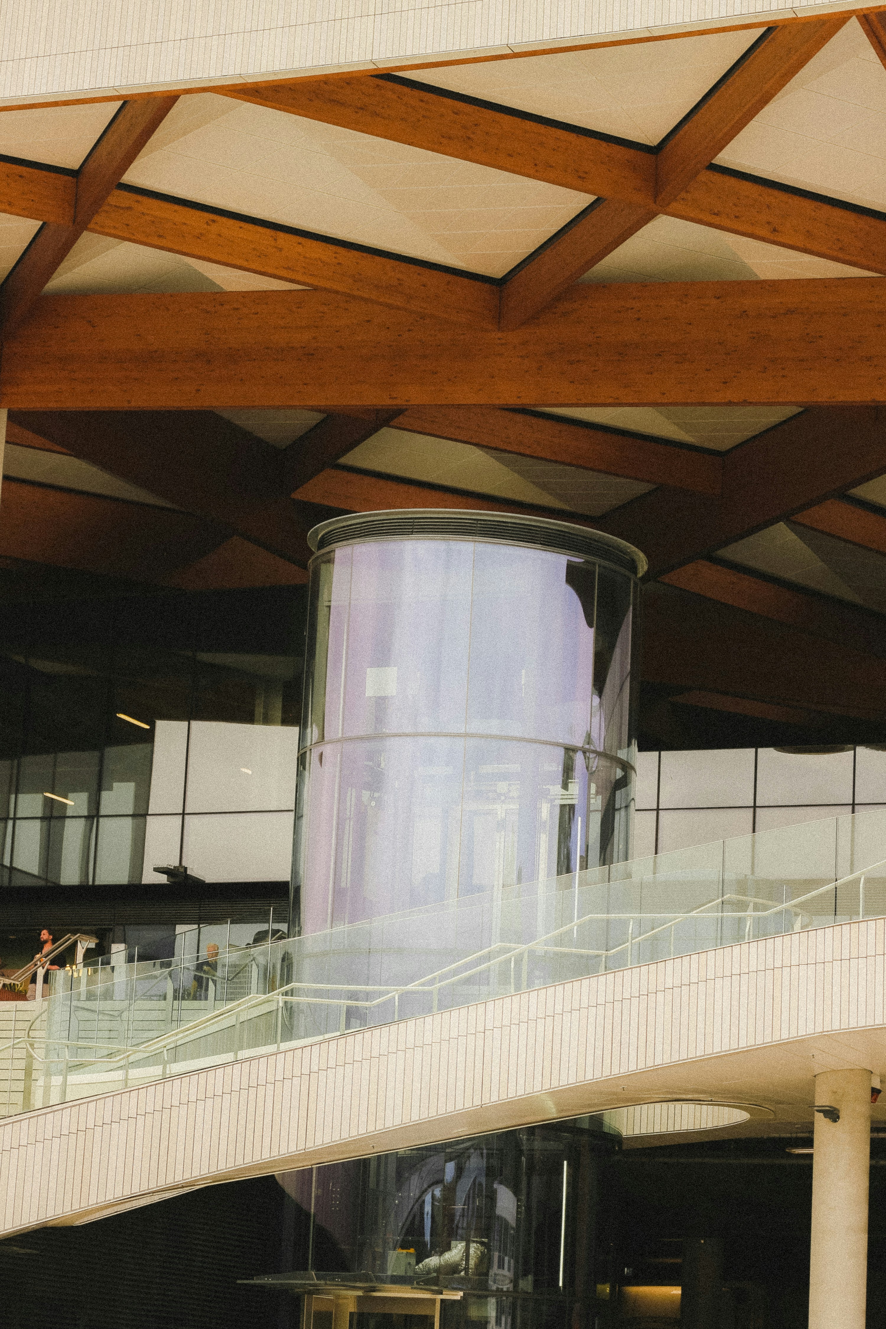 Geometric Timber and Glass: An Architectural Staircase Within a Modern Atrium