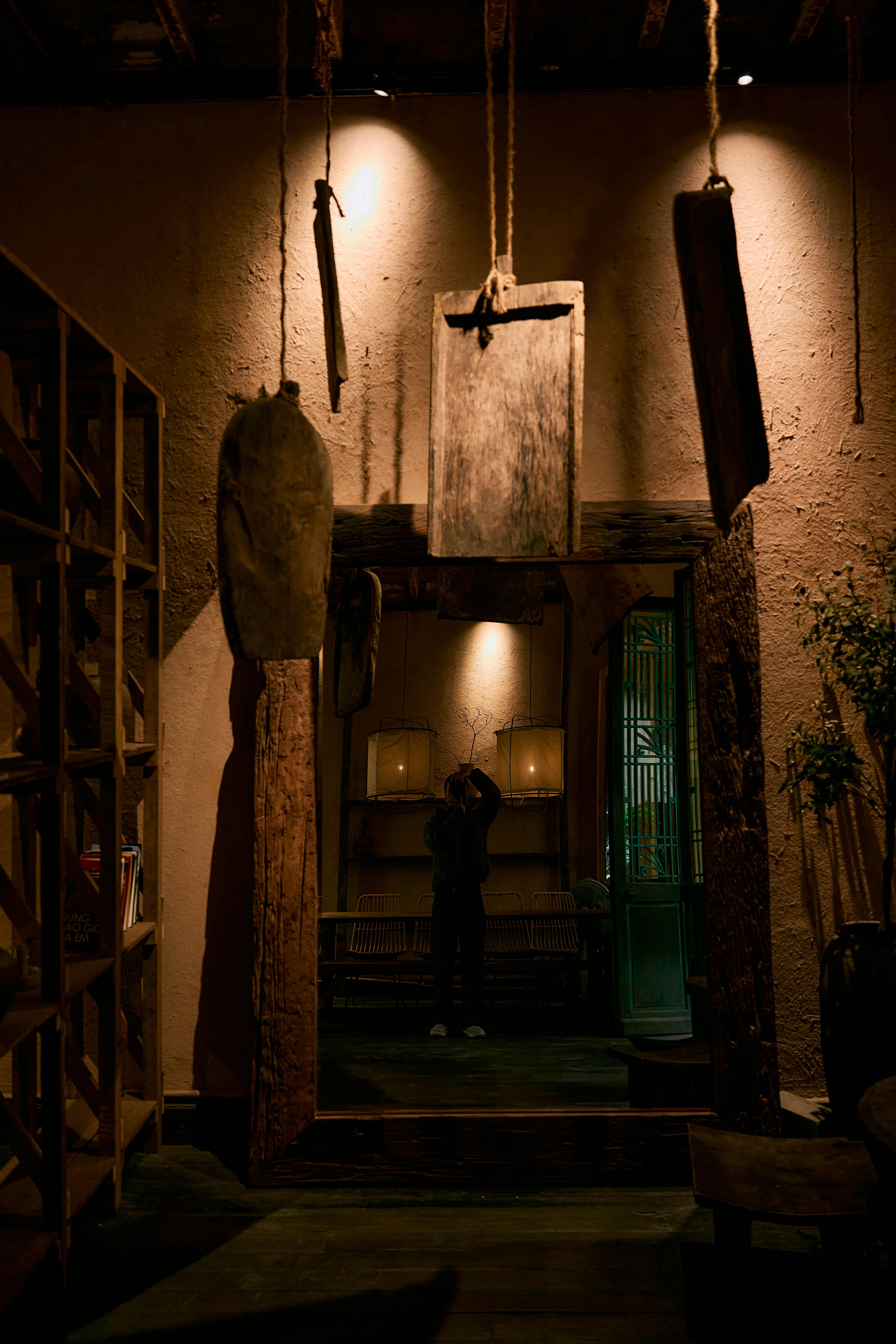 Hanging Threshold: Quiet Figures in a Dim Corridor