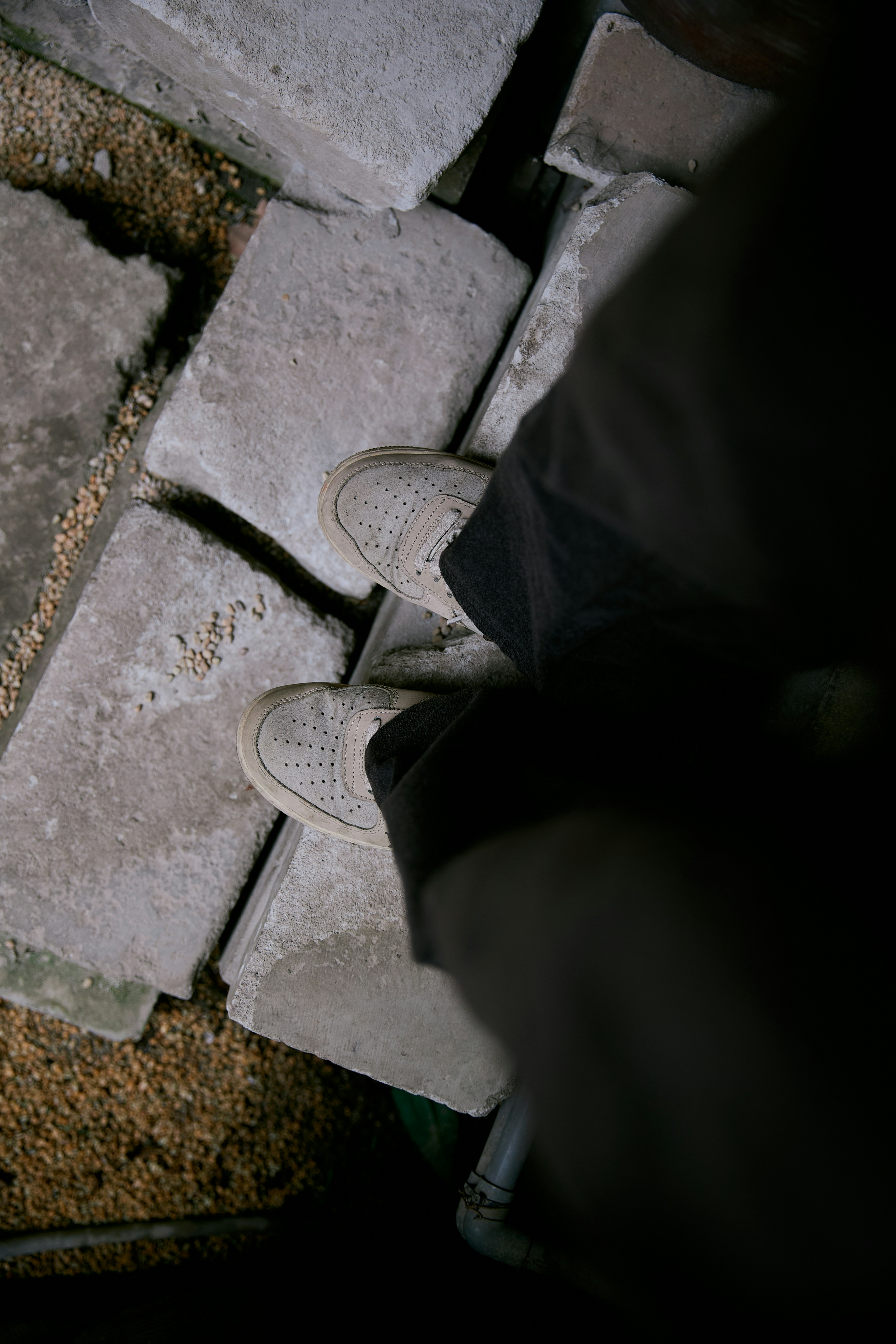 Grounded Steps: Beige sneakers on a rocky edge