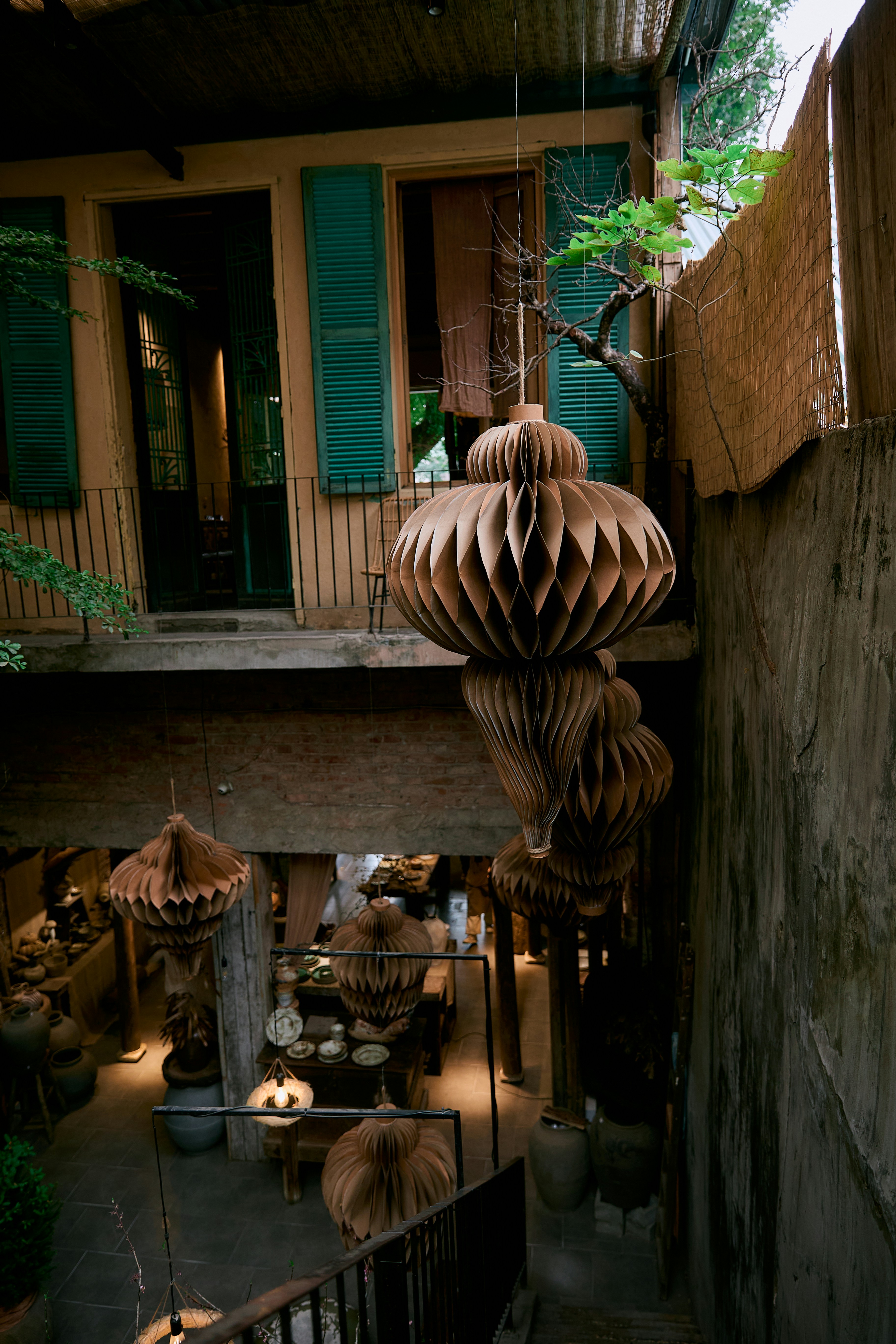 Hanging Lanterns Over a Quiet Courtyard in Warm Autumn Light
