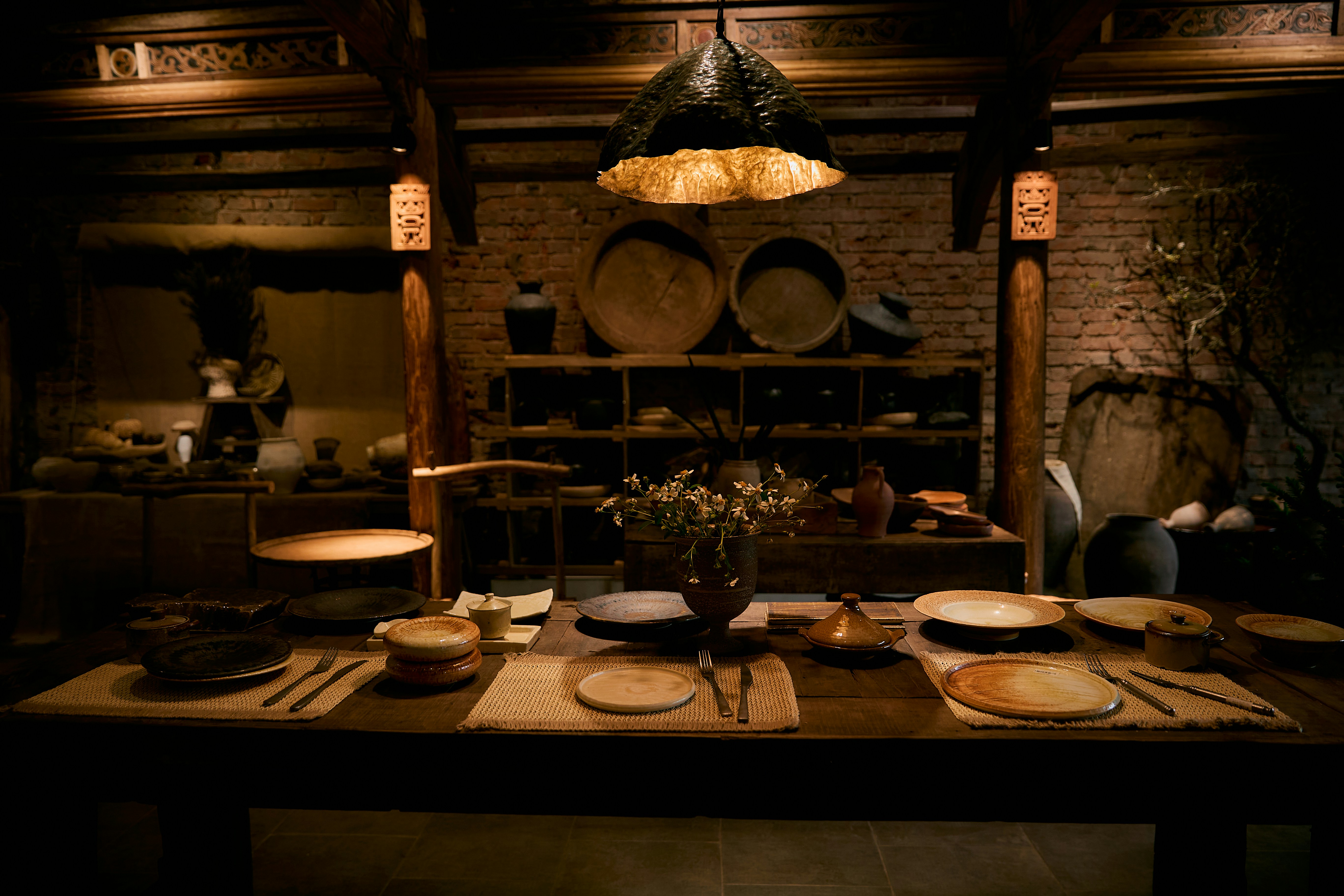 Warm Table Setting Beneath Central Lantern in Rustic Dining Room