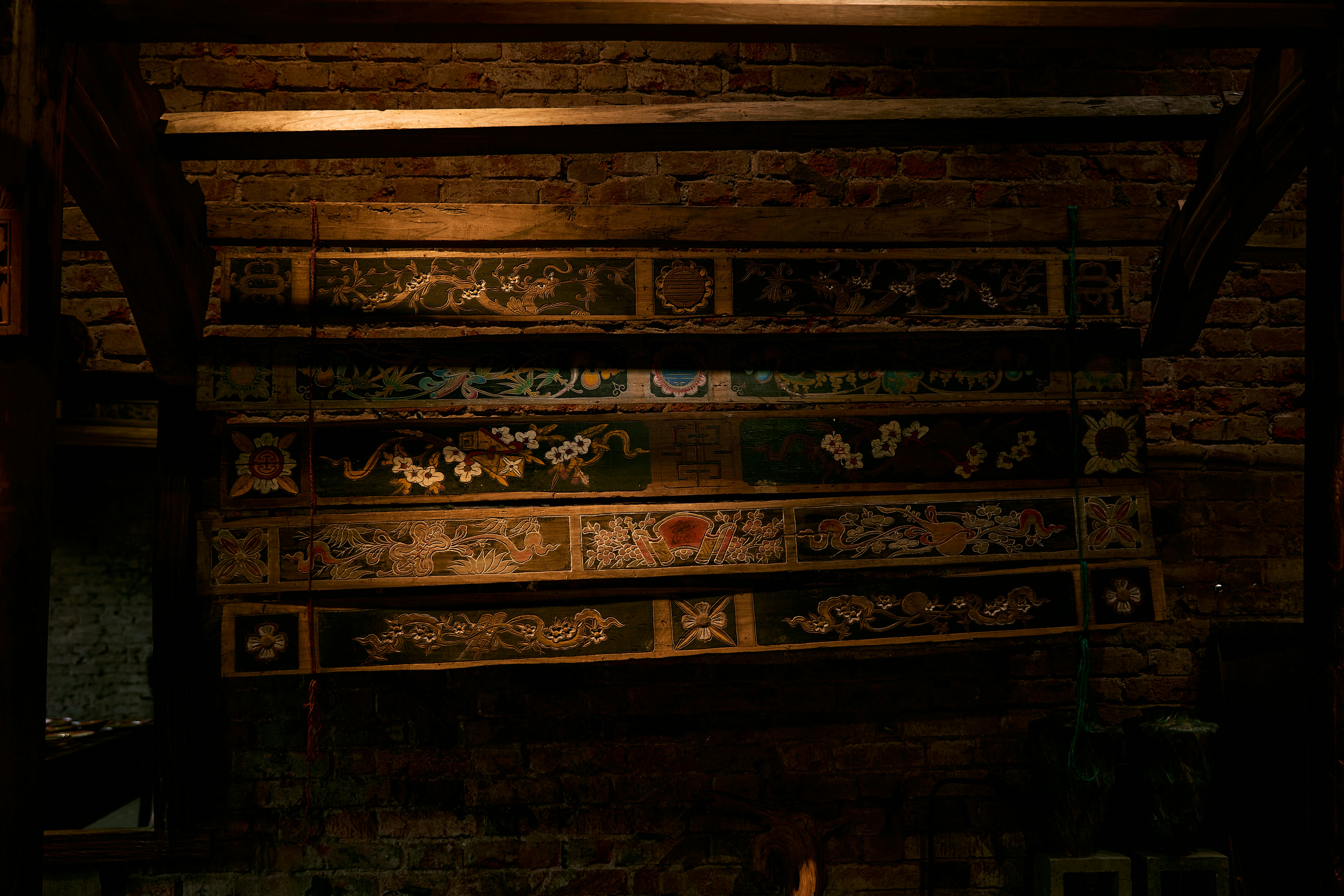 Low-lit Textile Gallery: Fragments of Pattern in the Brick Corner