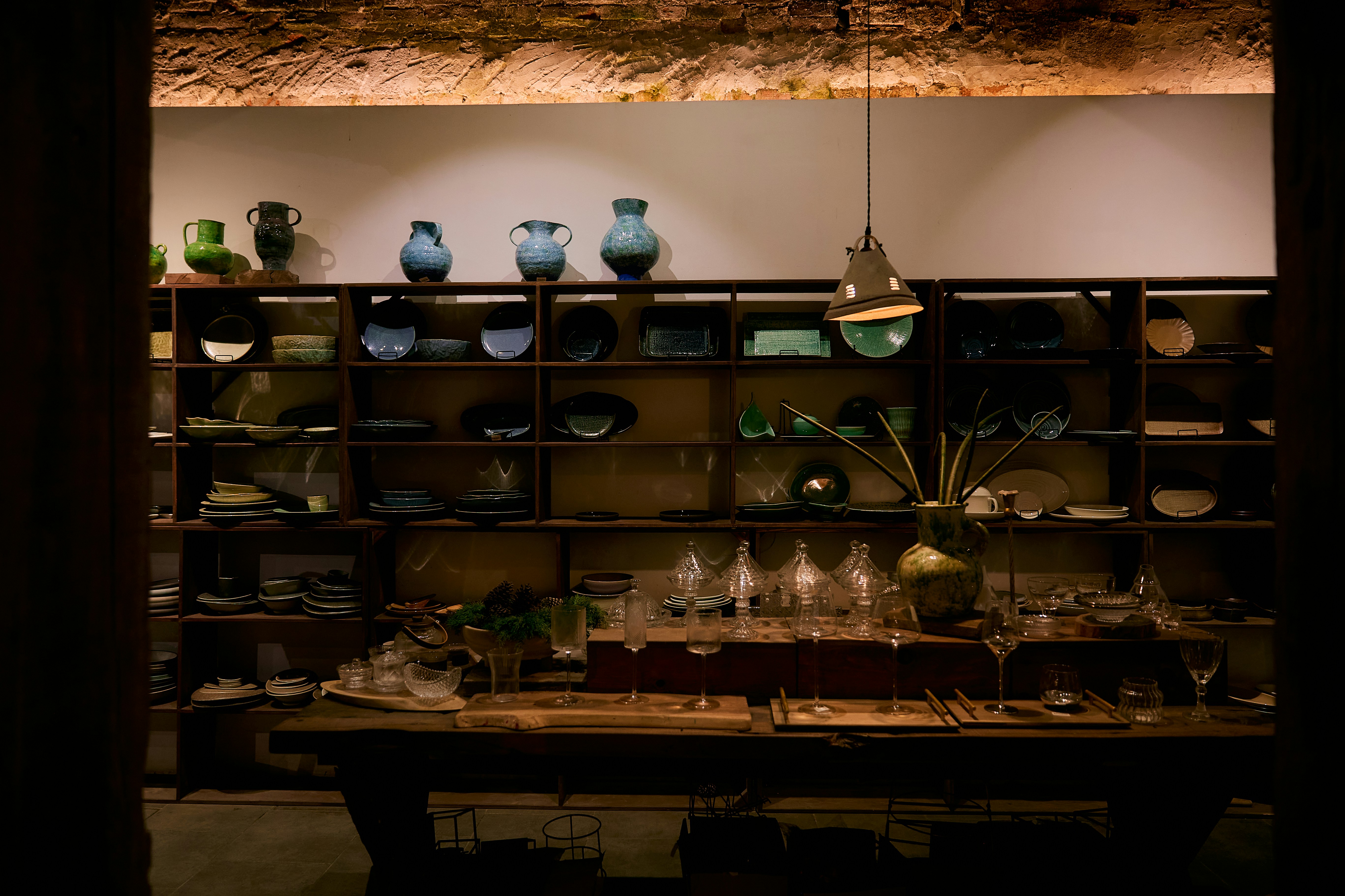 Shelves of Ceramics: Warm Lighting in a Ceramic Shop