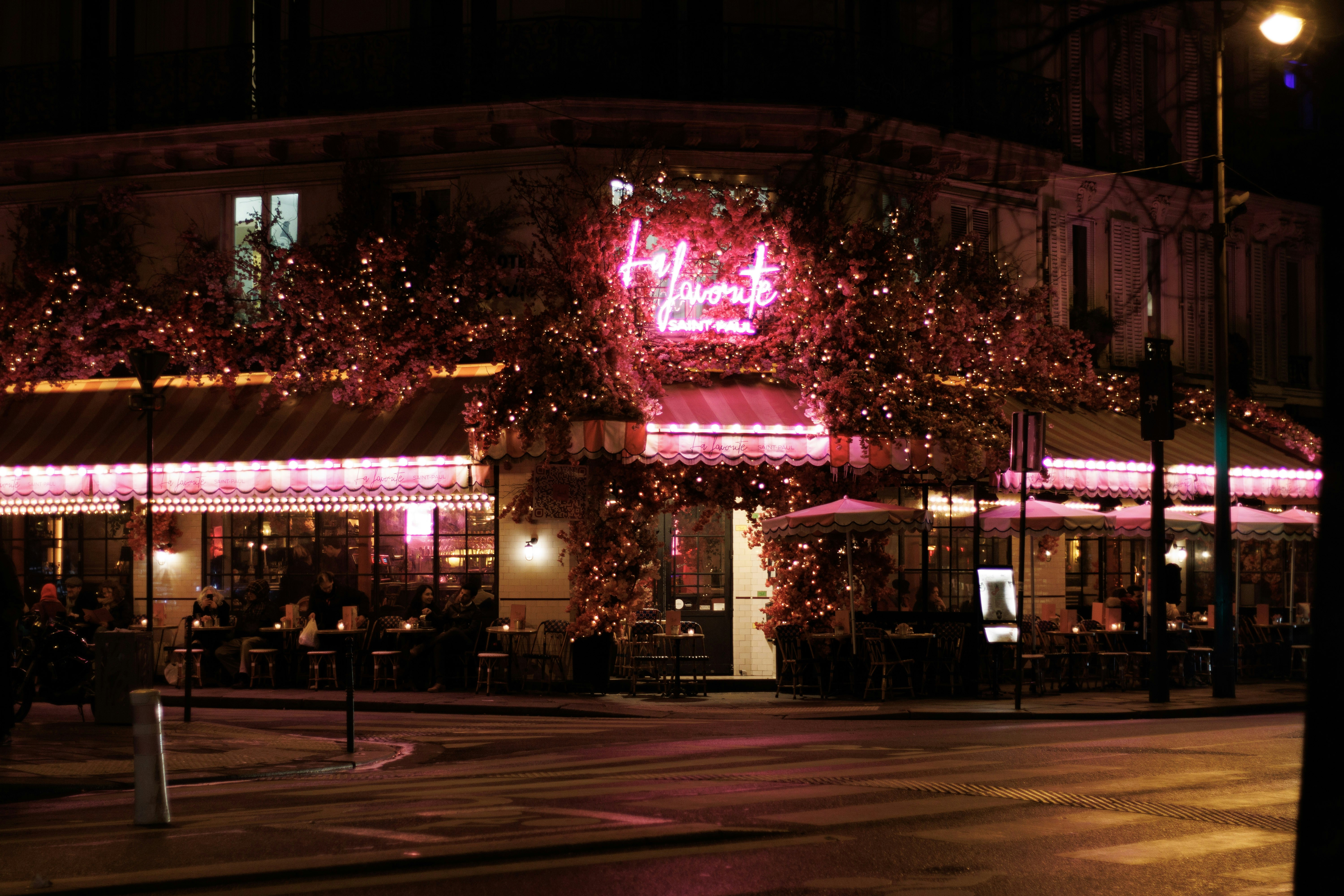 Neon Bistro at Night: Warm Lights under Holiday Trees