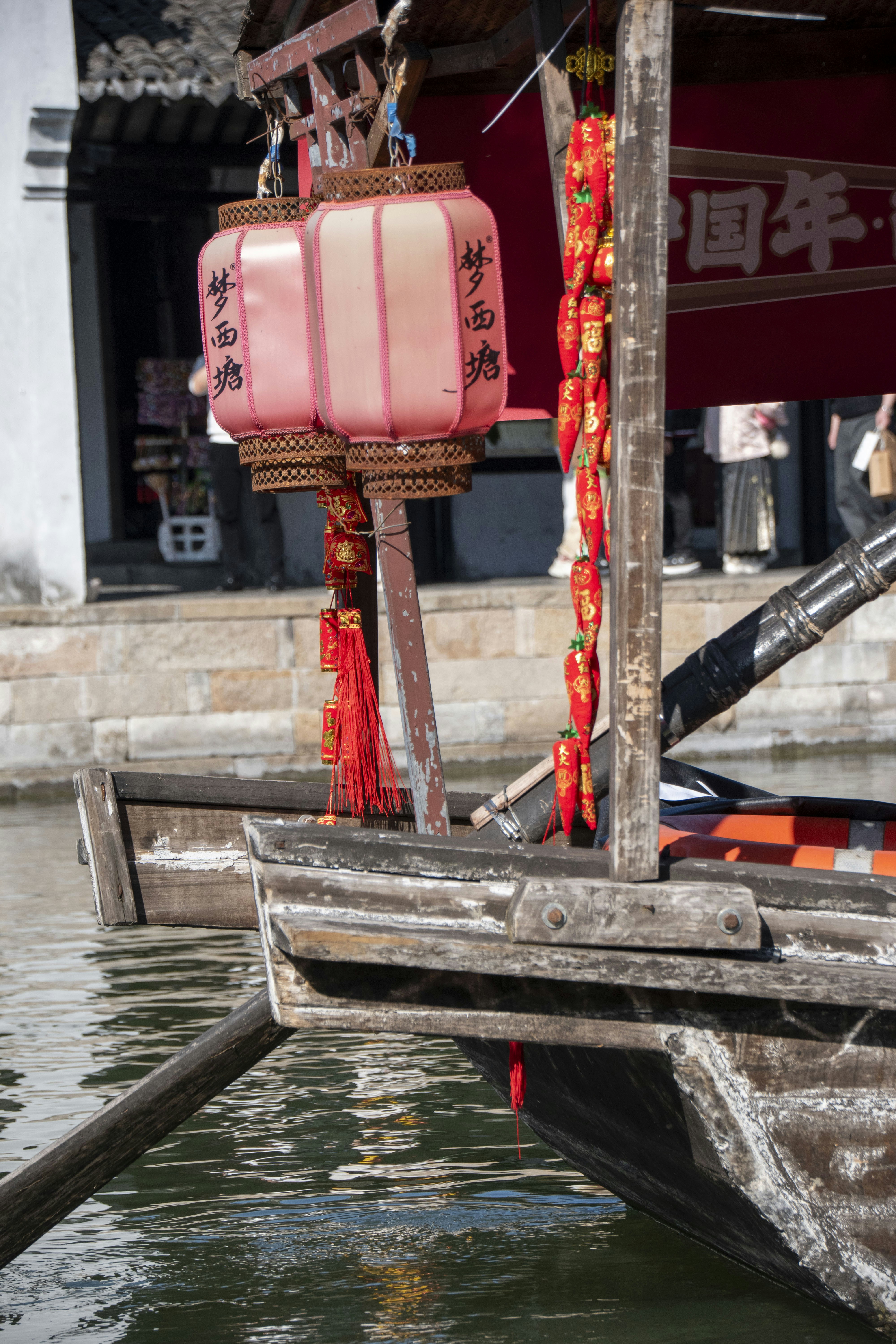 Pink Lanterns Above the Boat at a Riverside Temple