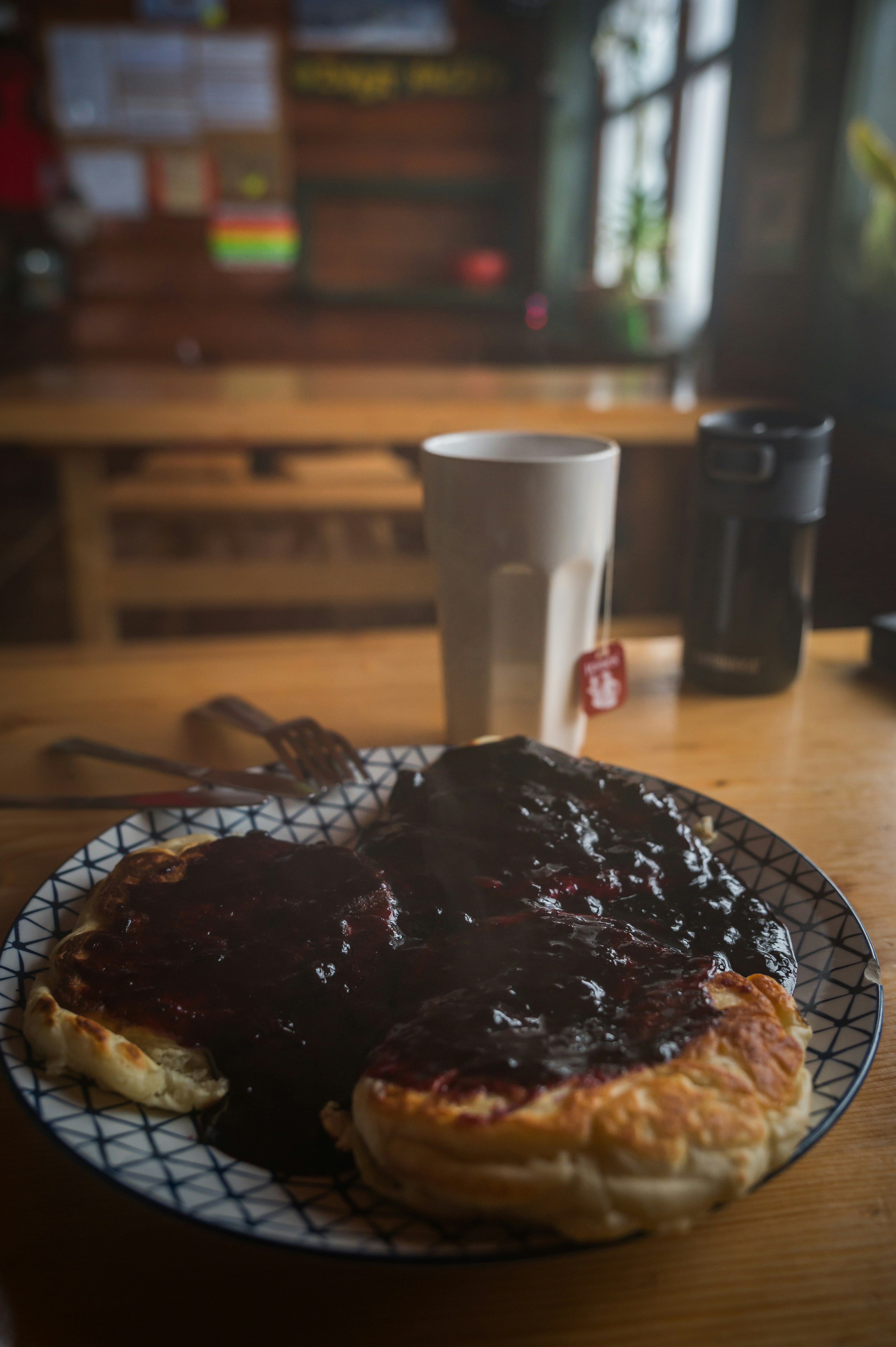Sticky blueberry glaze crowns a rustic breakfast plate in a cozy café
