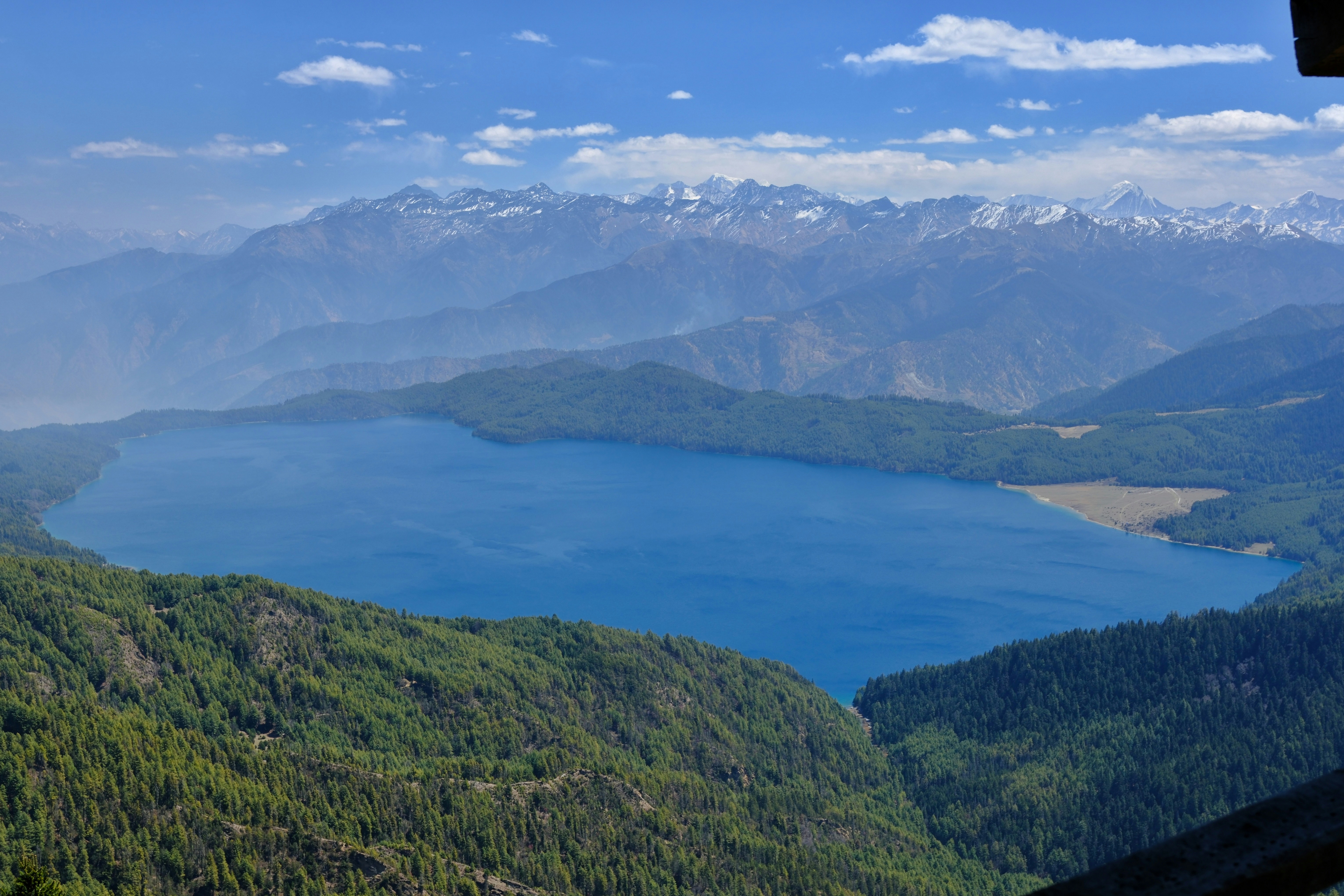 Azure Mirror: A Mountain Lake Carved Between Green Ridges