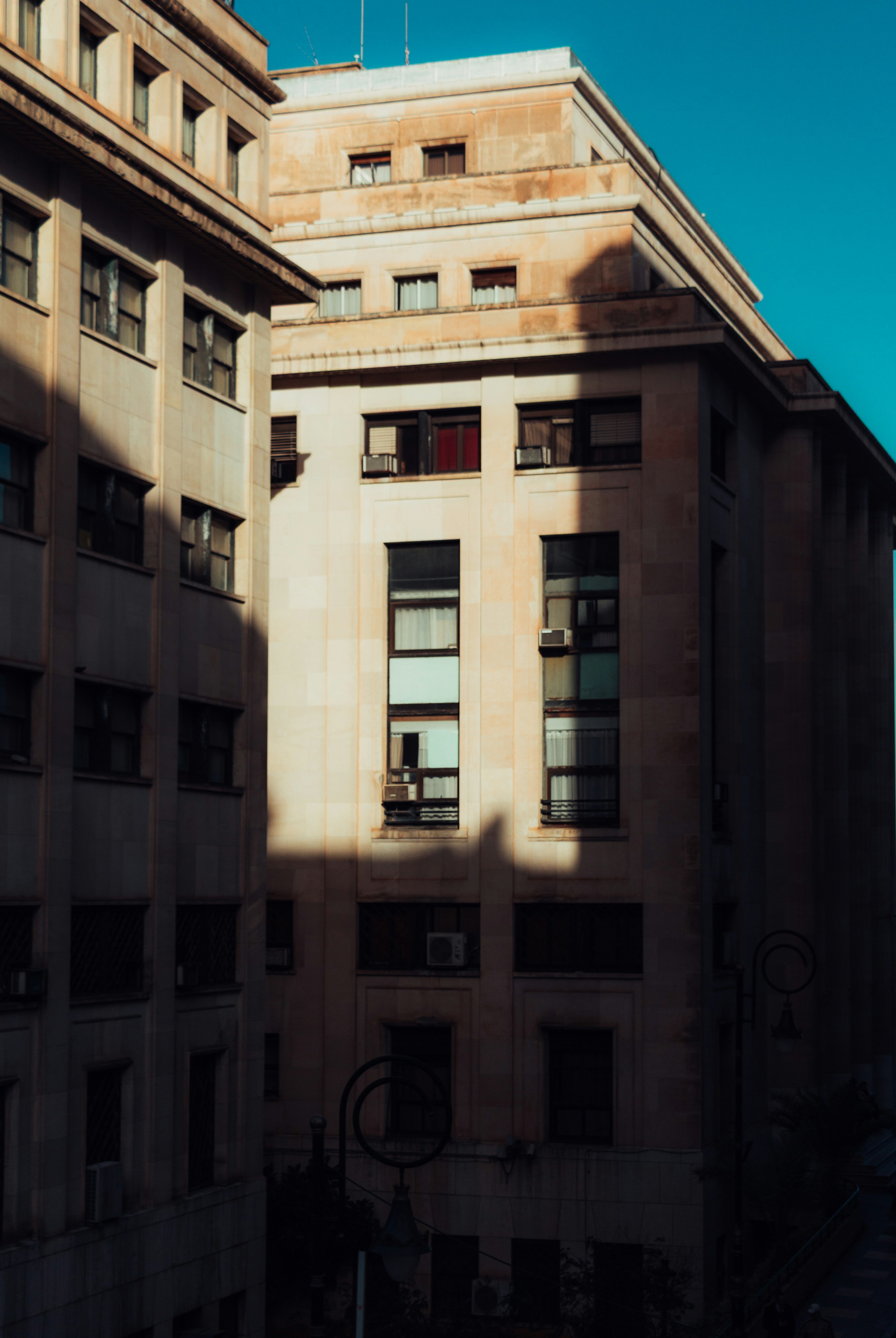 Sunlit Facade Shadows: A Tight Urban Canyon Between Stone Levels