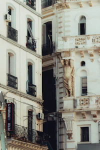 Statue Framed by Classic Facades: A Quiet Corner of Urban Heritage