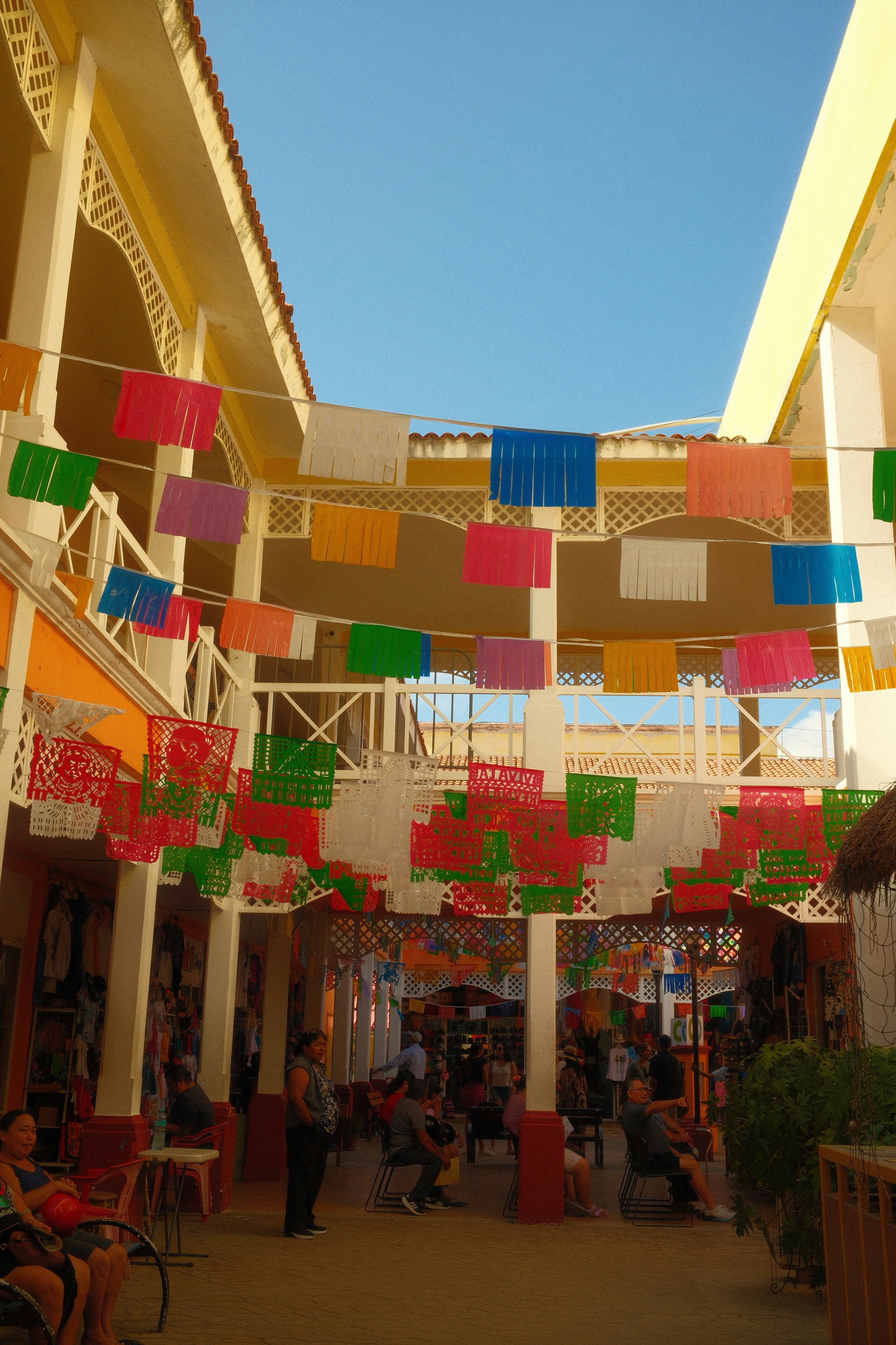 Colorful Flags Over a Sunny Courtyard Bazaar