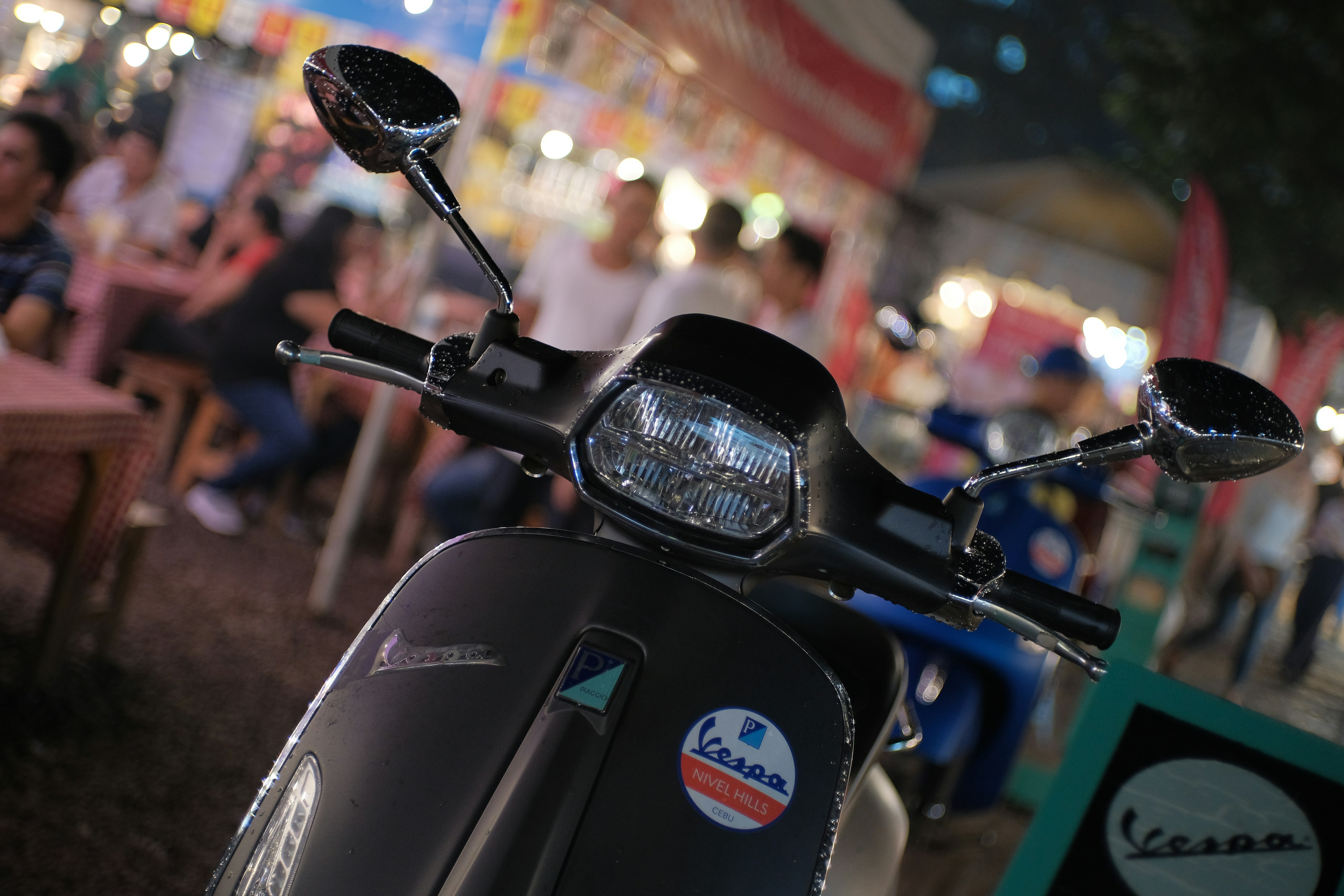 Front View of a Scooterscape: Centered Noir of a Matte Black Vespa