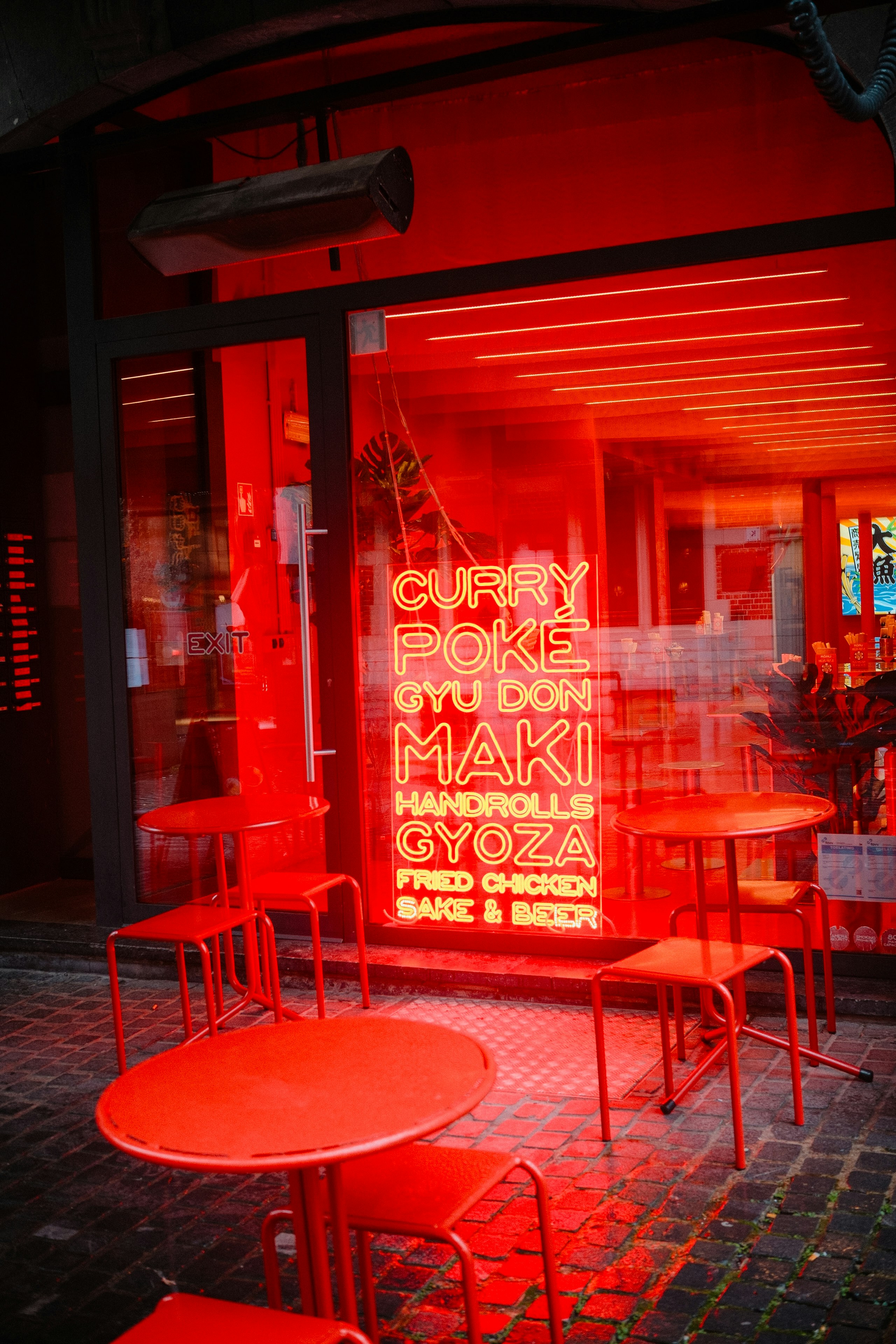 Neon Red Café: A Glowing Menu Frame Through Glass