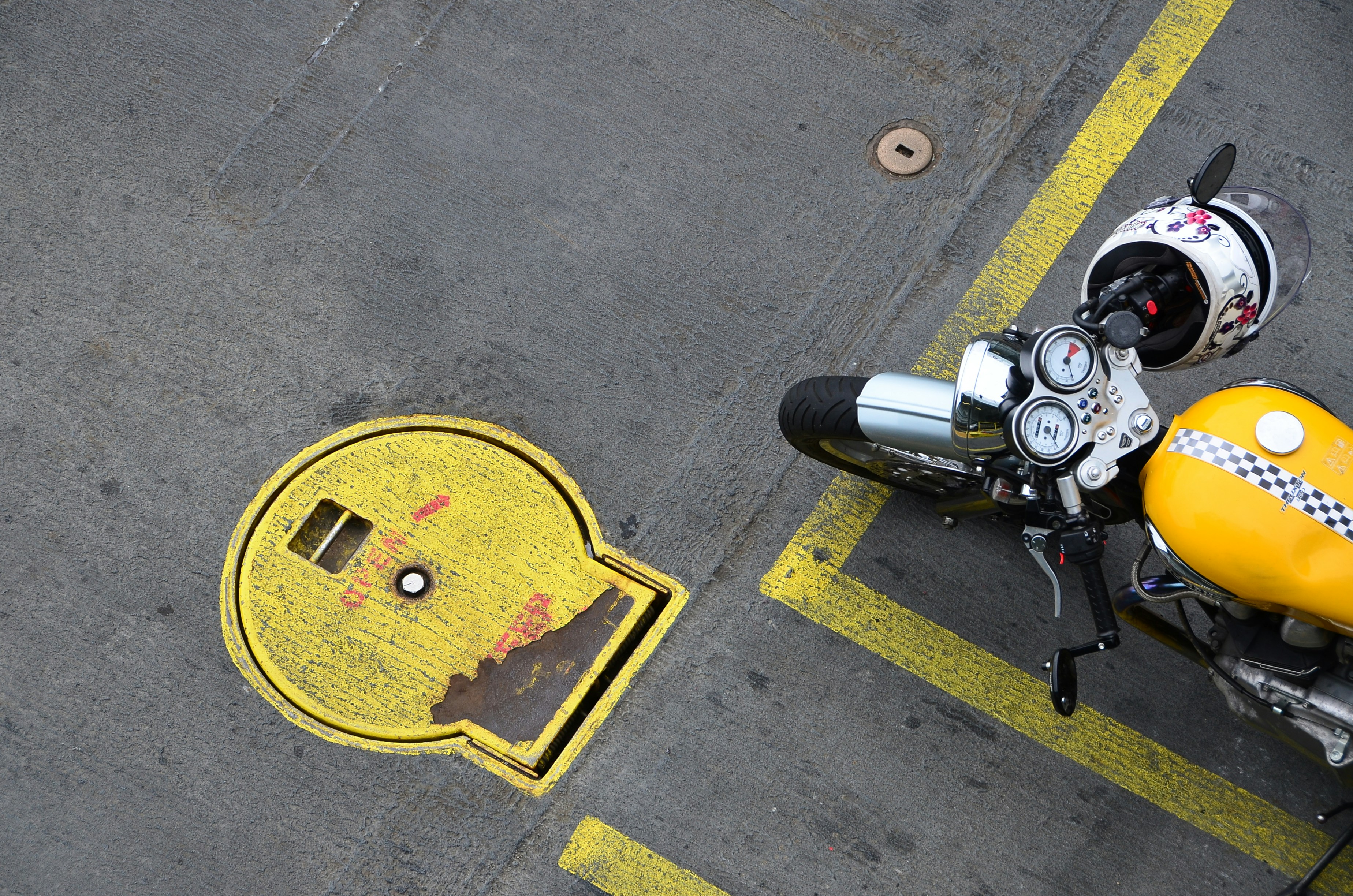 Yellow Streak: A Neon-Flick Motorcycle Resting by a Painted Line