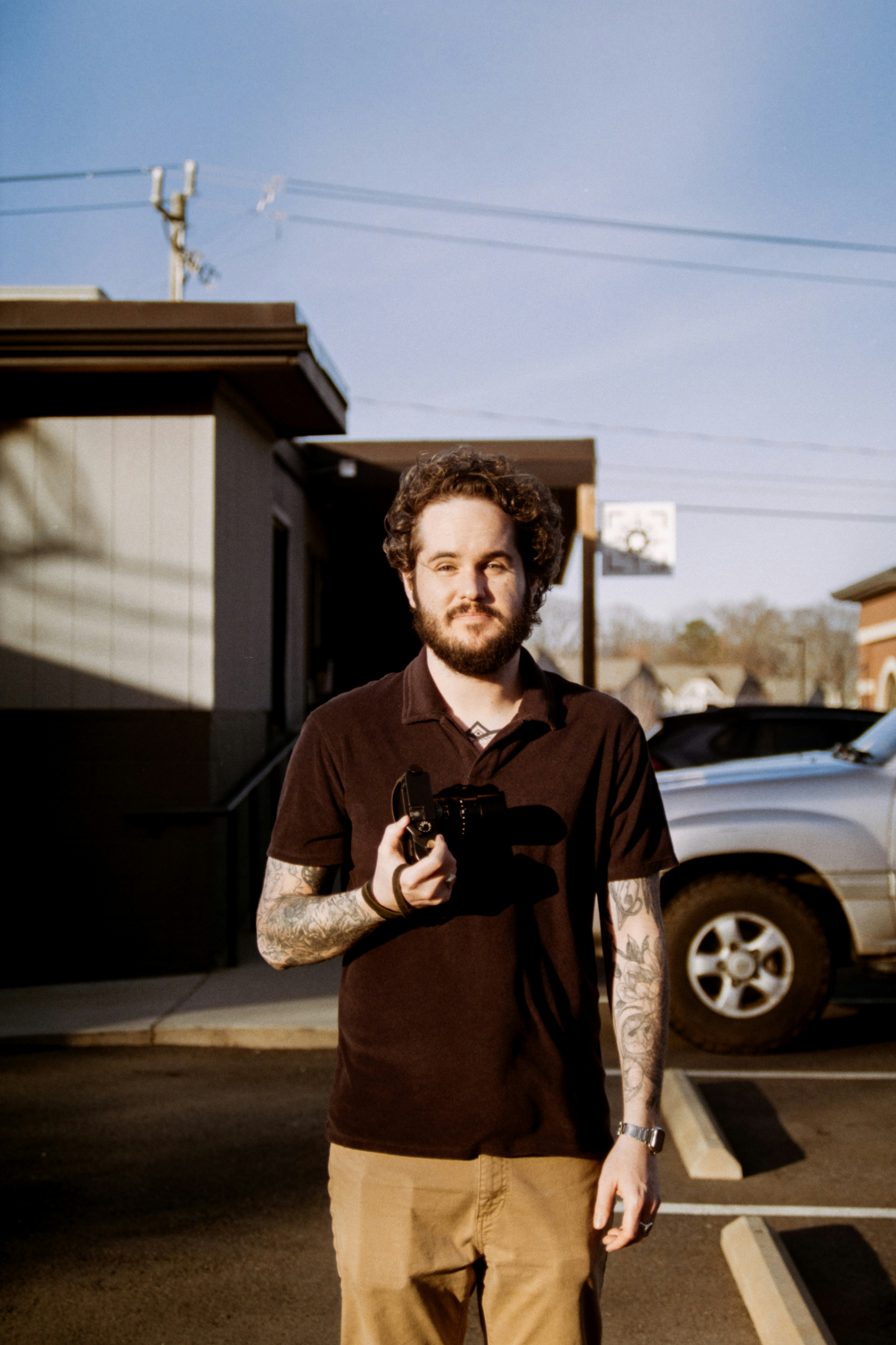 Camera Portrait in a Sunlit Parking Lot