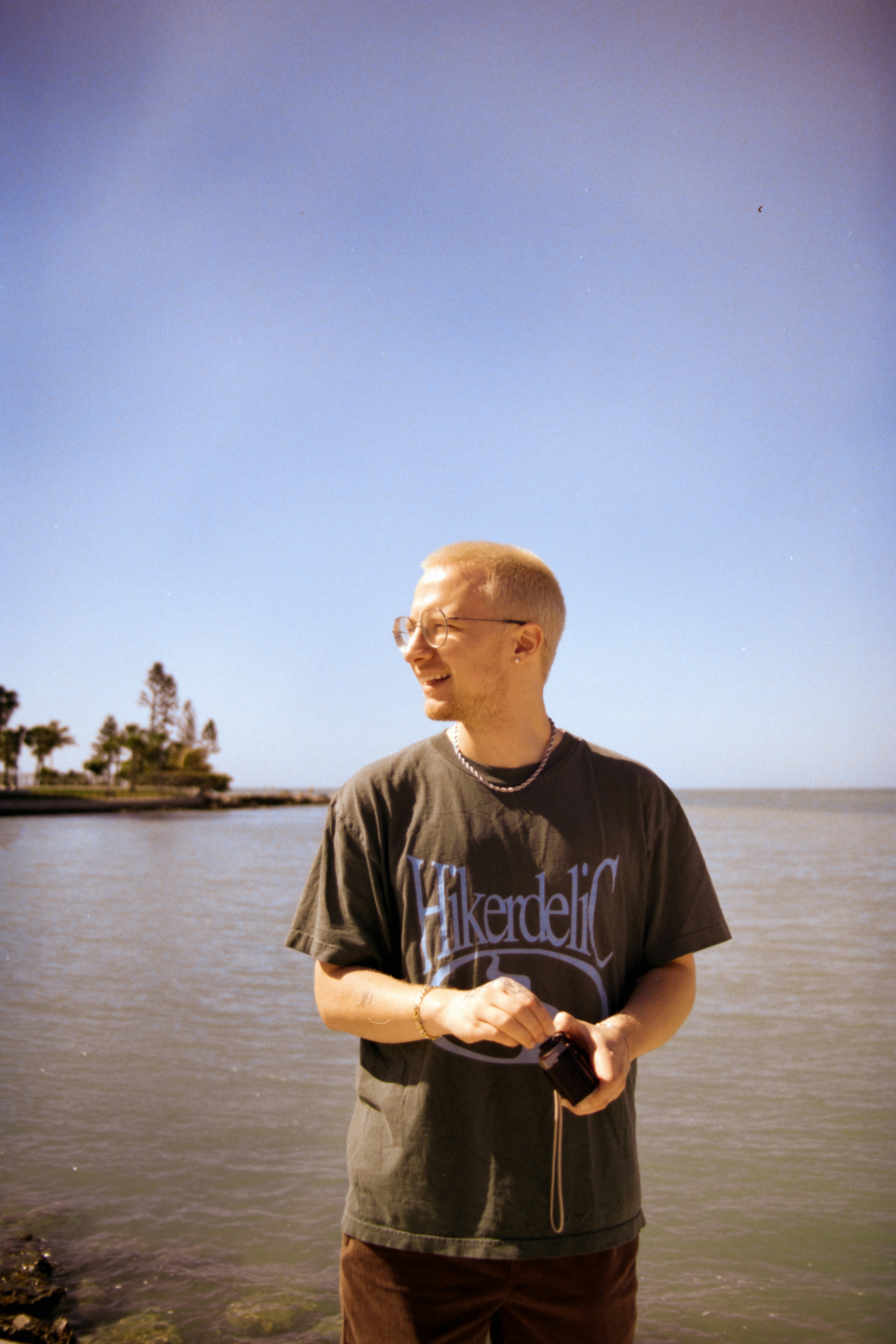 Sunlit Laugh by the Shore: A Portrait by the Quiet Water