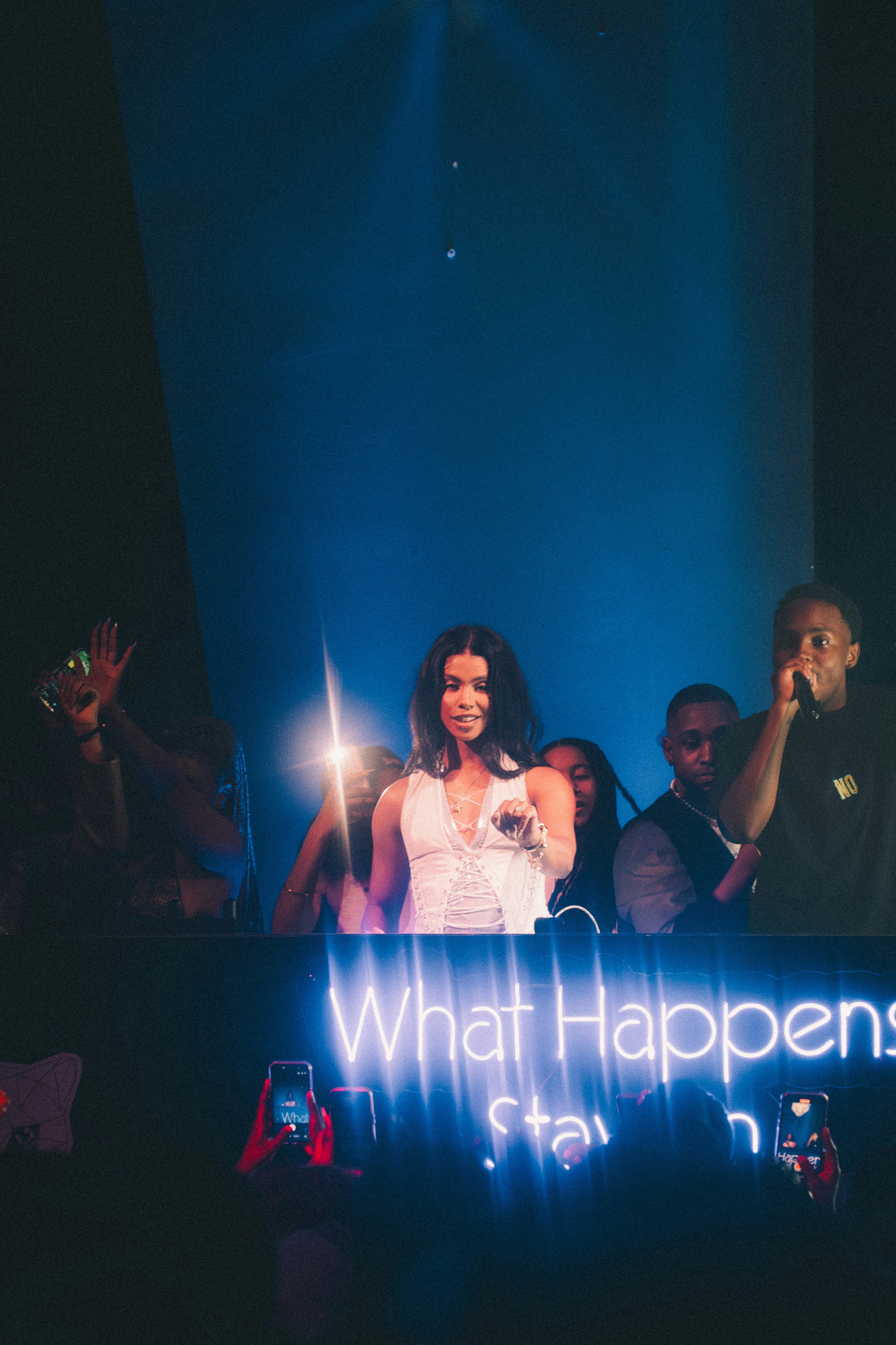 Center Stage Neon: A vocalist under blue spotlight at a concert