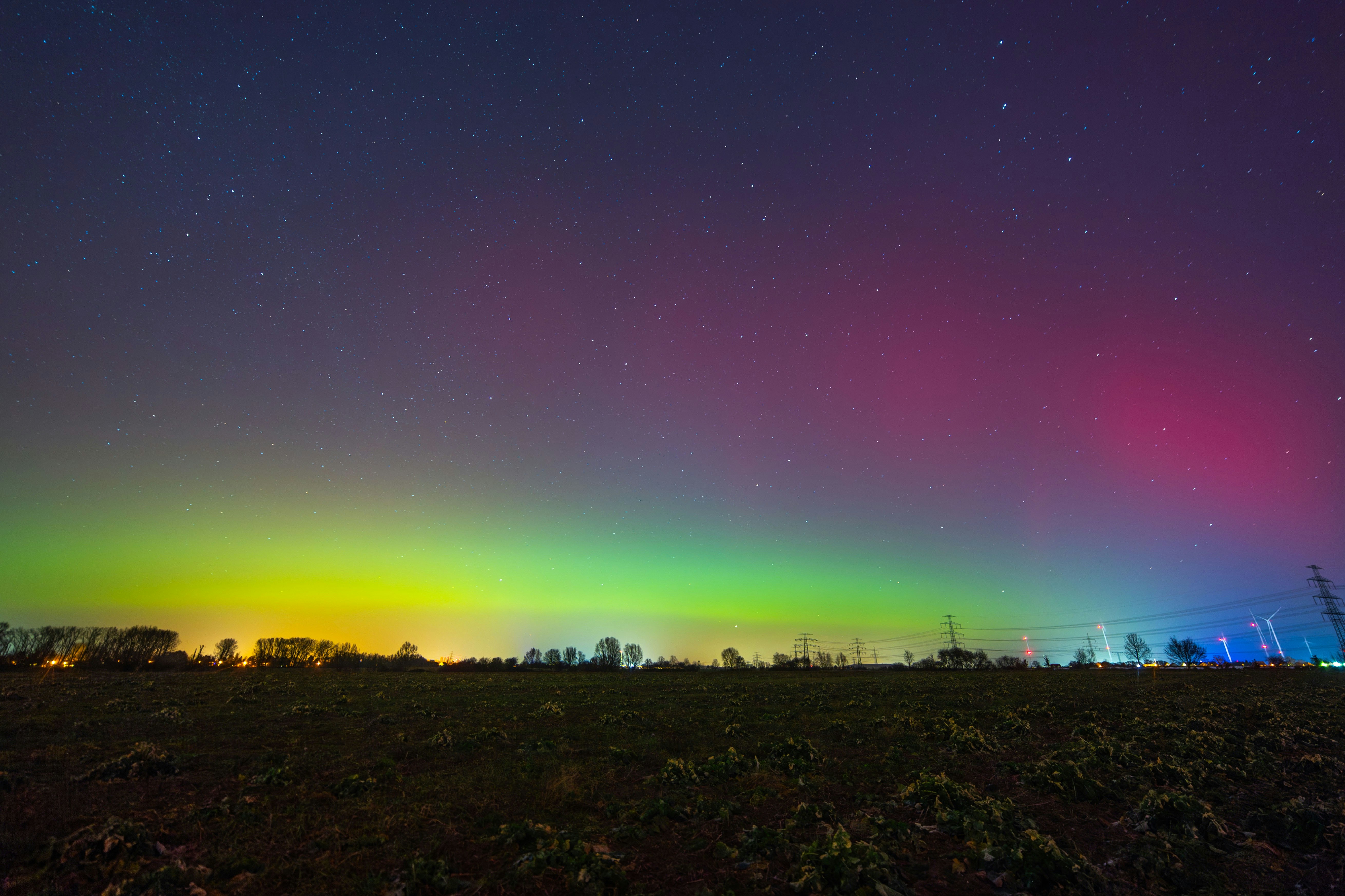 Aurora Over Fallen Field: A Night Portrait of Colored Skies