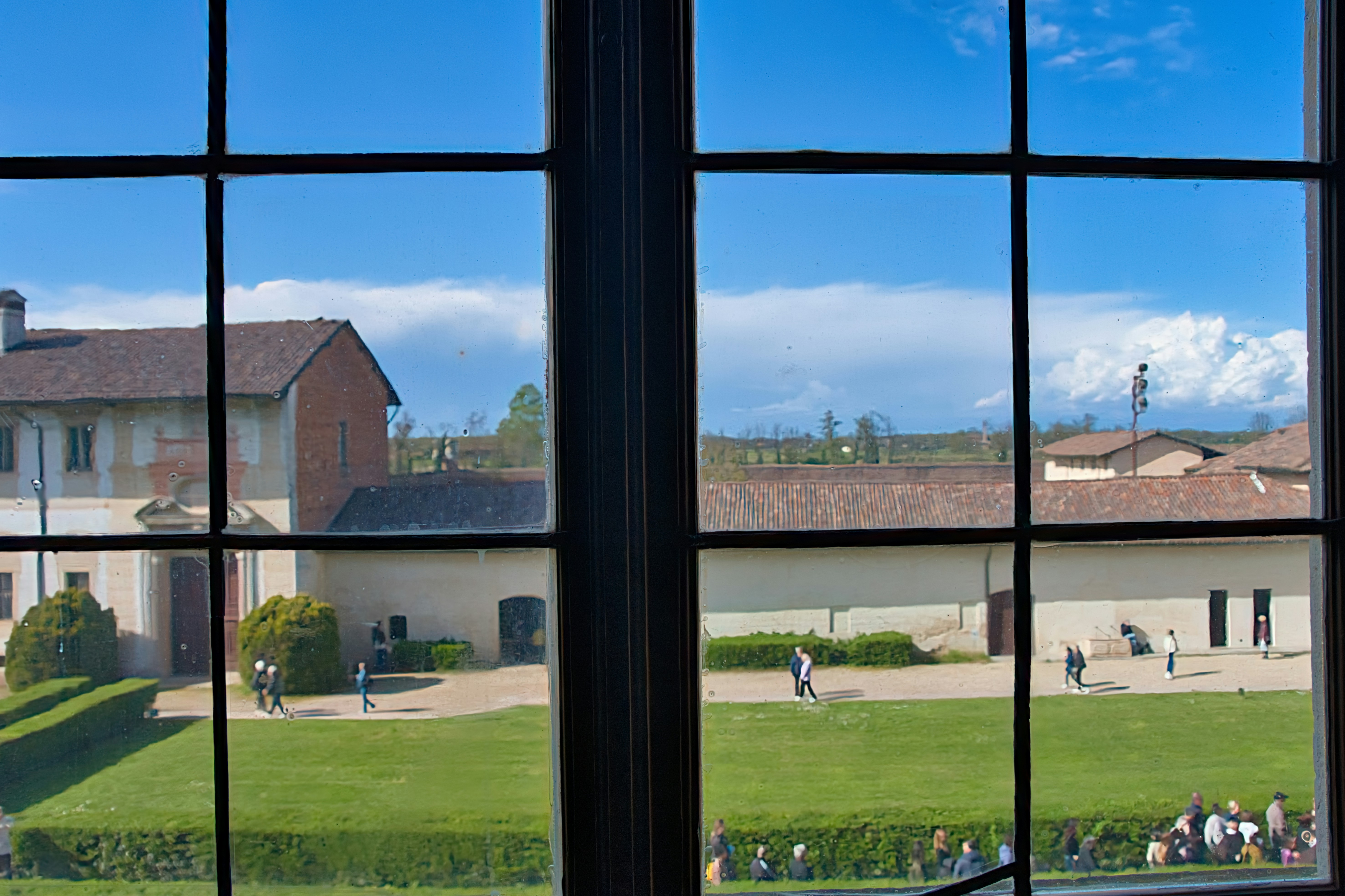 Campus courtyard through a grid window