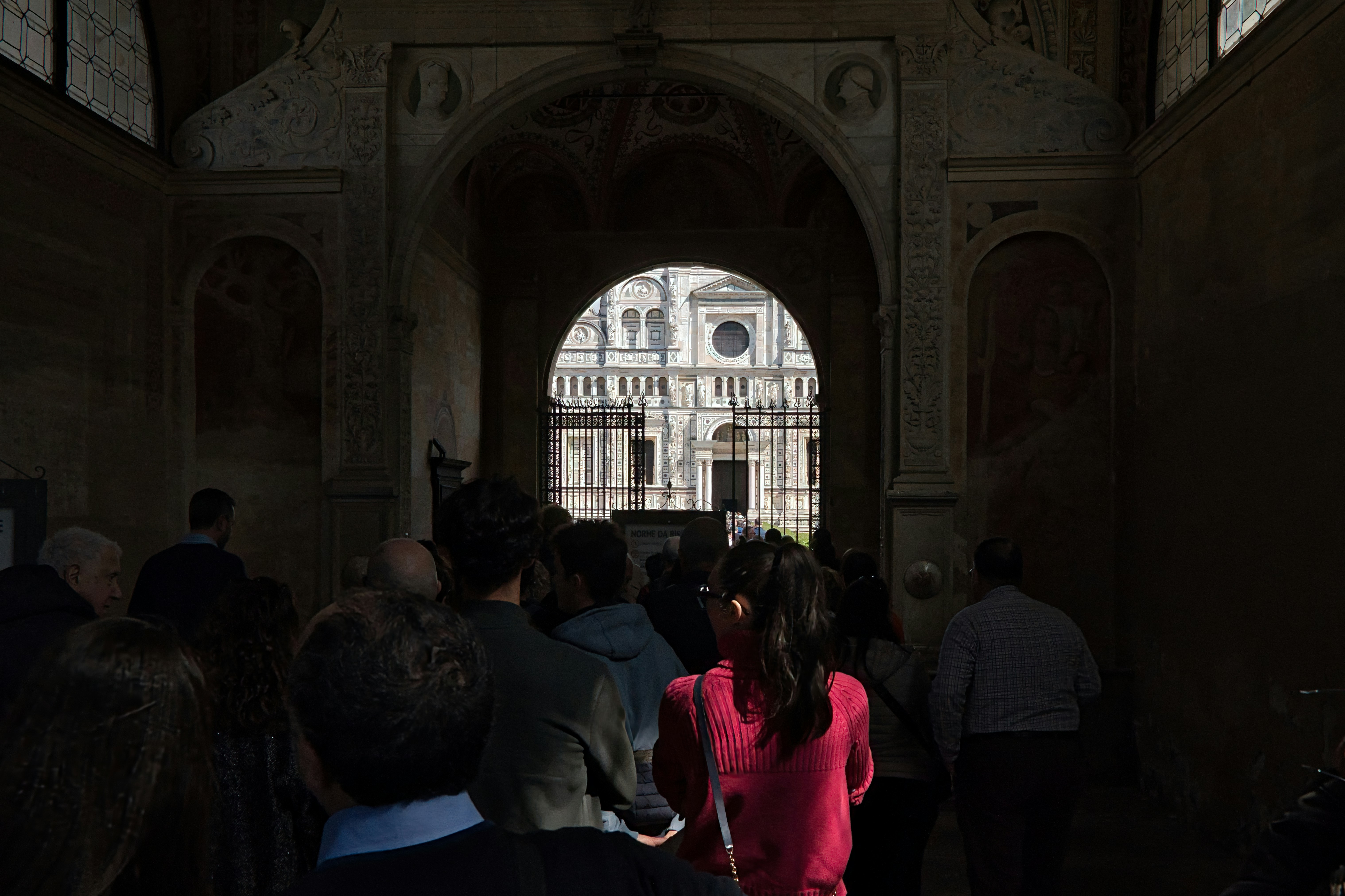 Through the Dark Arch: A Crowd Gathers Beneath the Gallery Portal