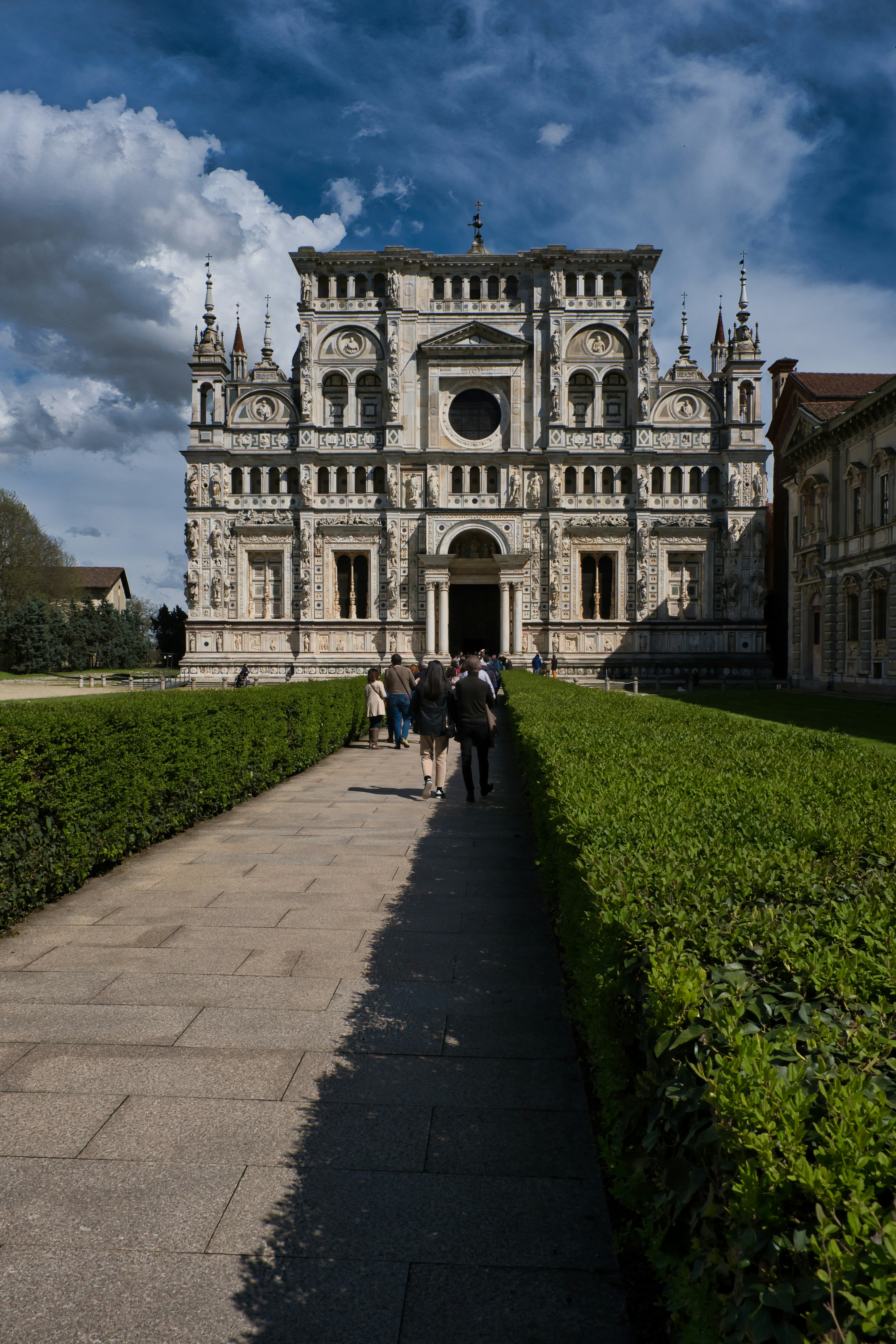 Pathway to the Facade: Travelers Approach a Historic Marble Structure