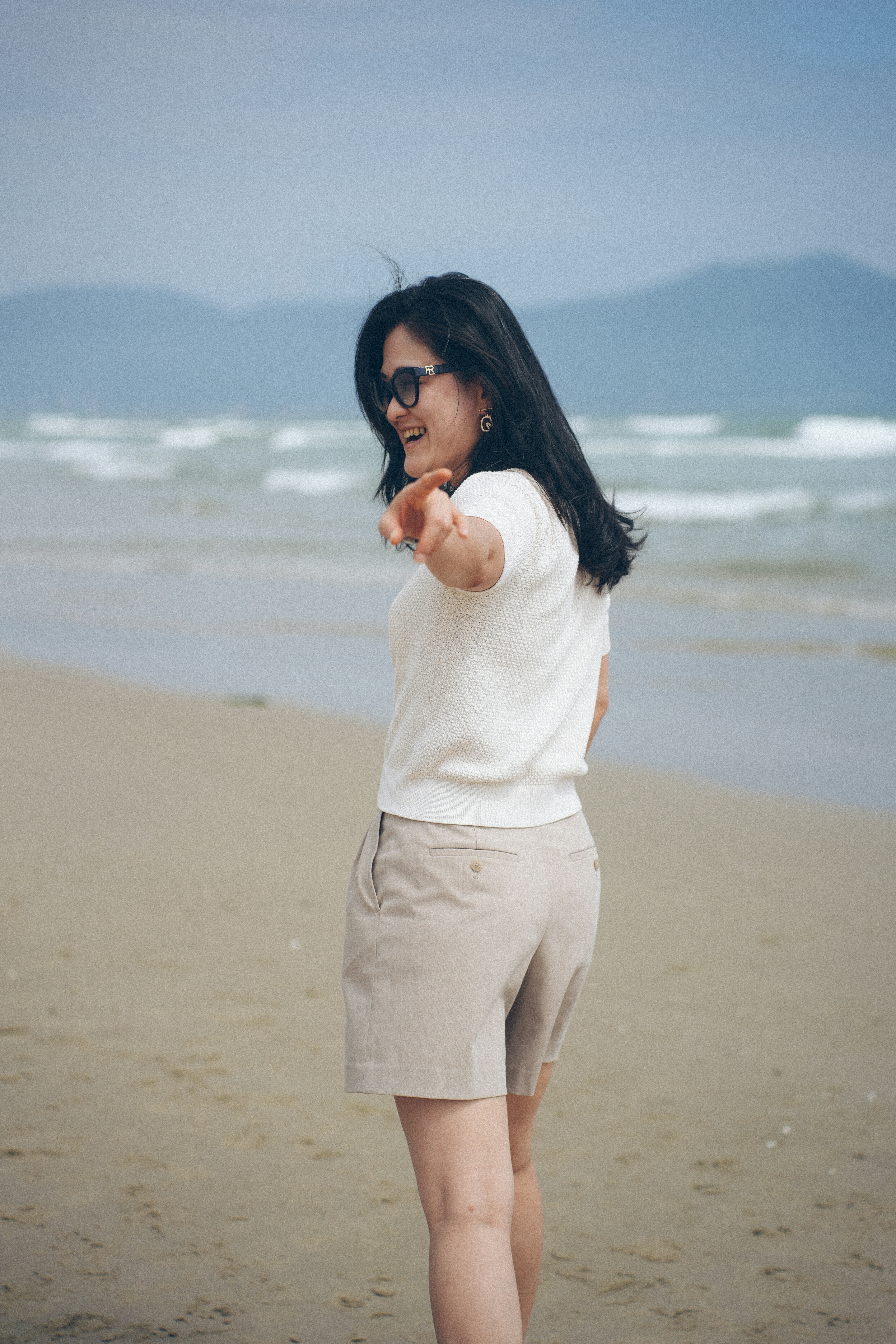 Pointing Out at the Shore: A joyful beach moment